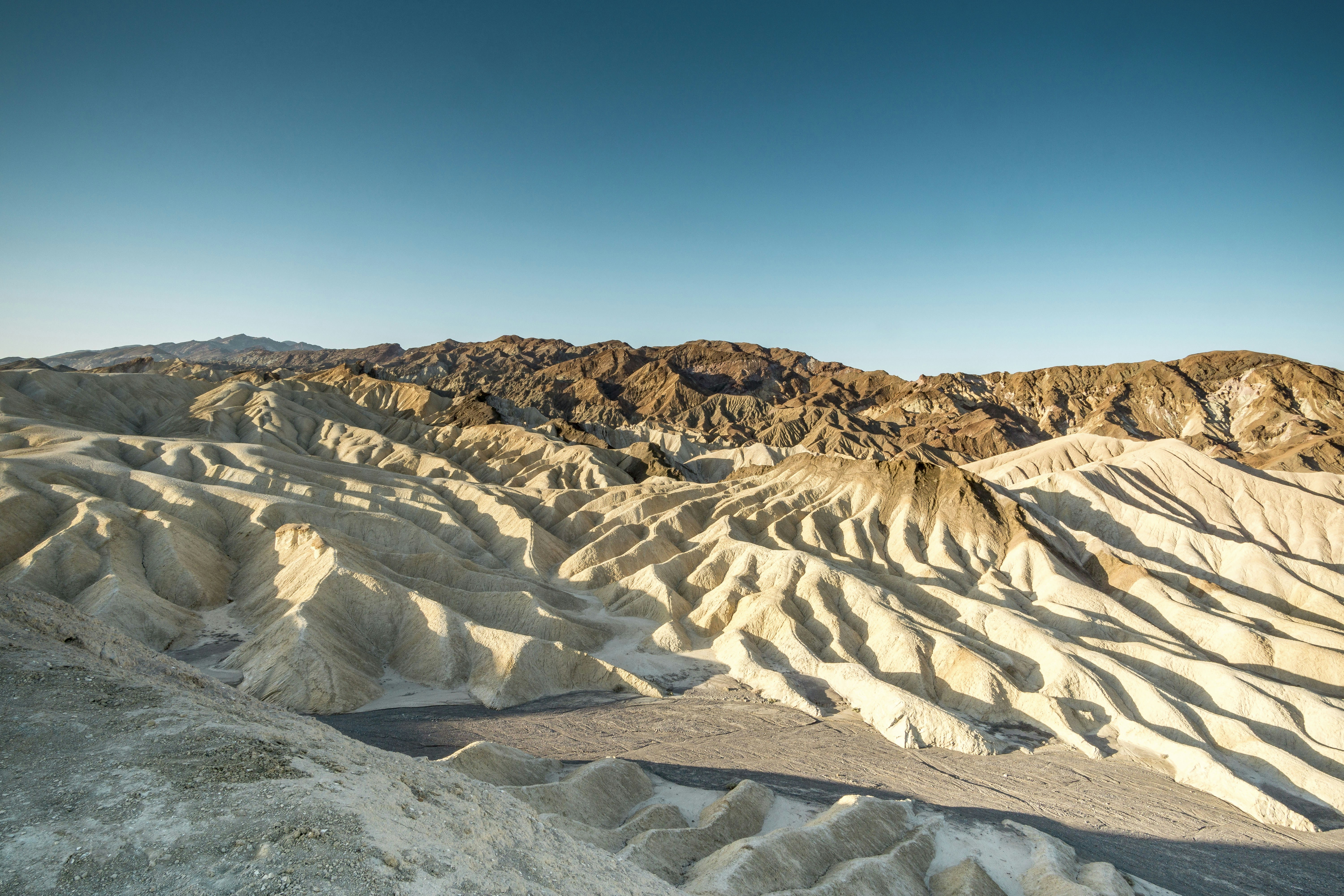 Unique geological formations in a vast desert landscape showcasing the intricate patterns of erosion. The scene captures the stark beauty of nature's artistry.