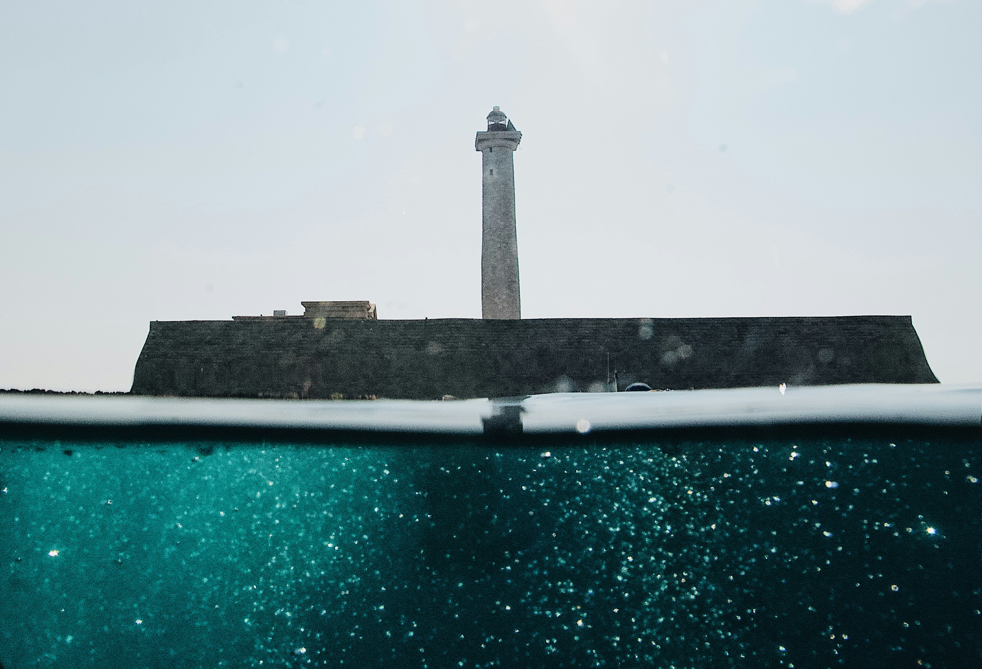 Sea-Gleam Lighthouse: A Distant Watch over Churning Blue
