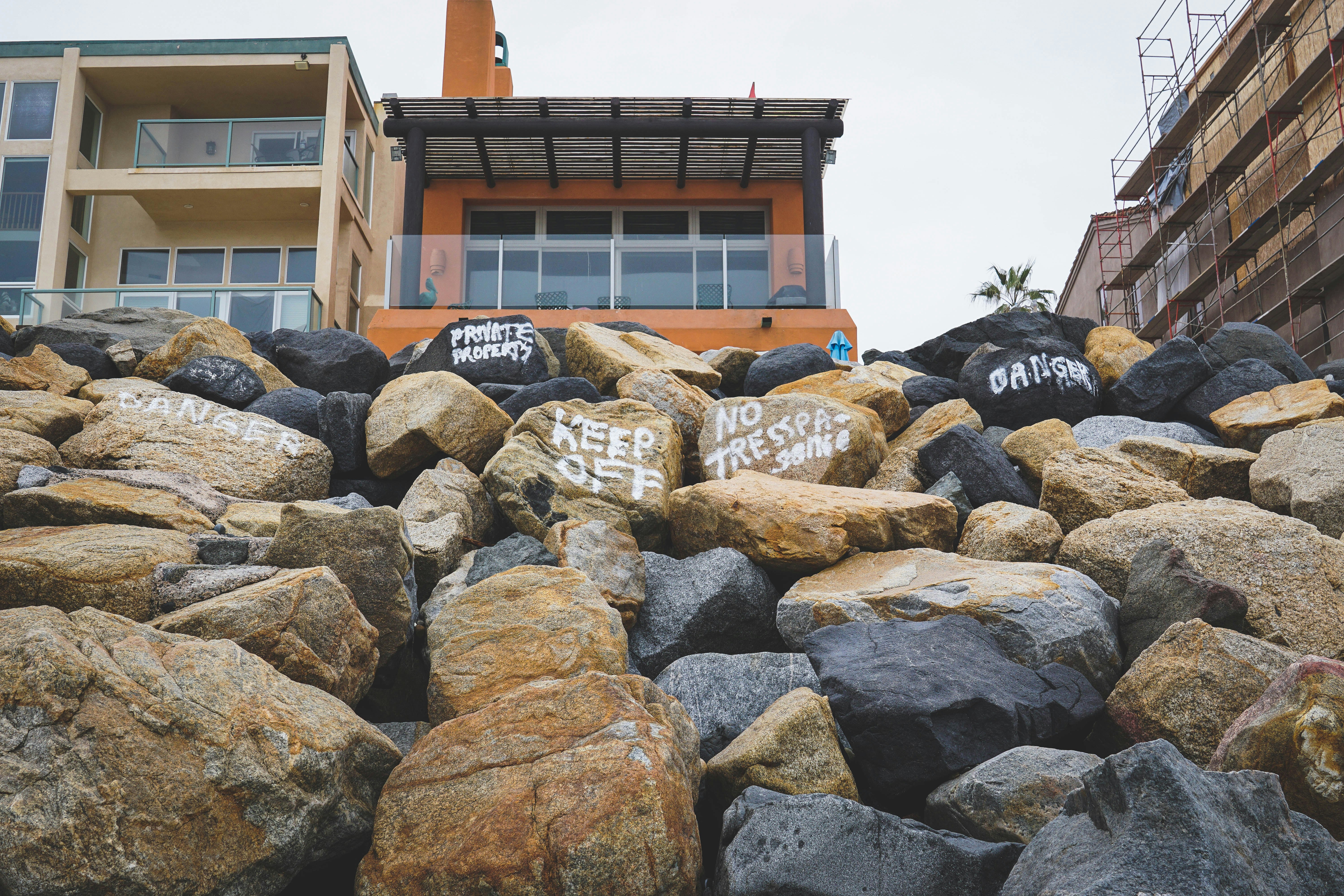 Breakwater Graffiti: White Messages Rise from the Seaside Boulders