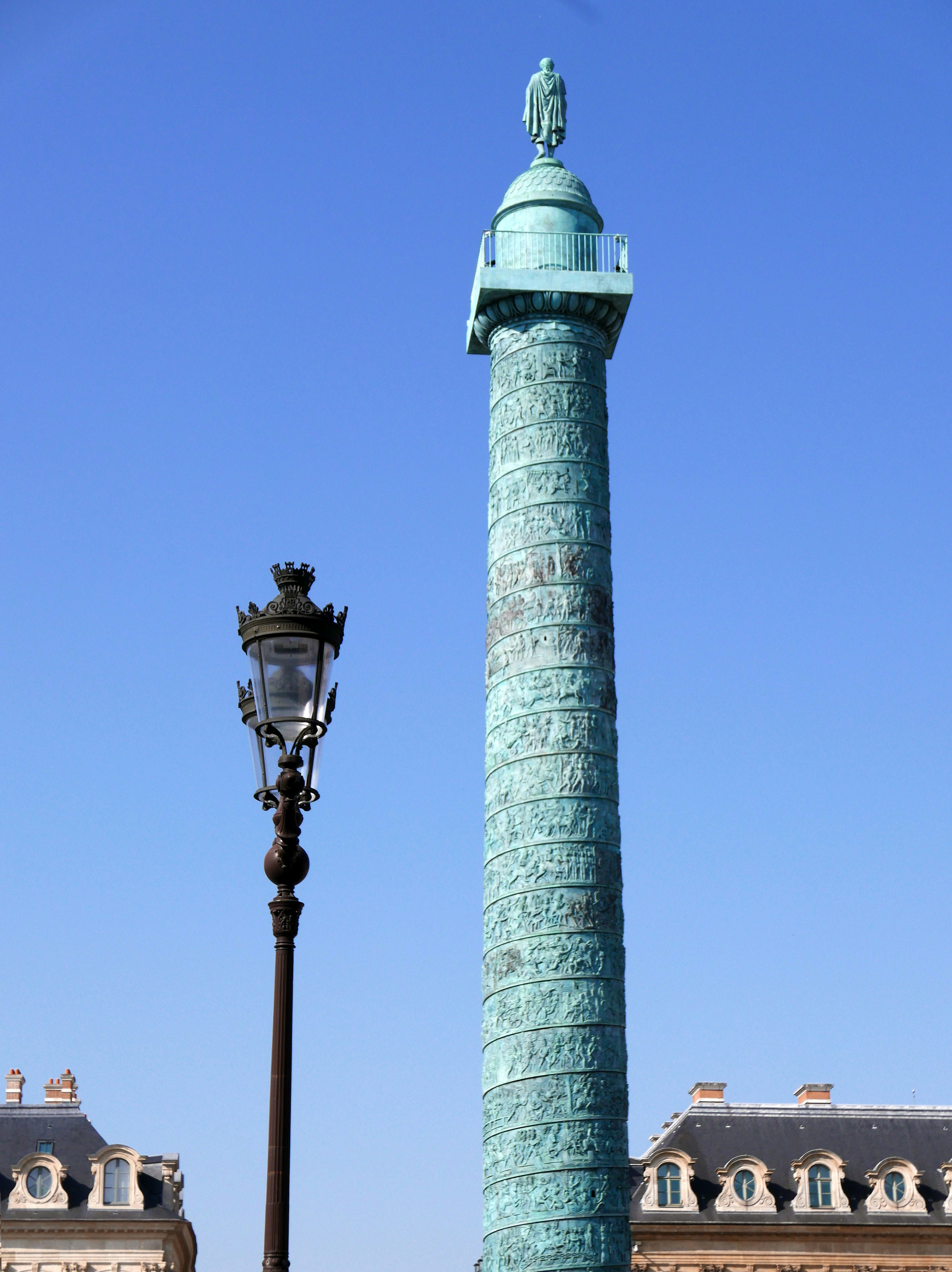 Blue Column of History: A Sunrise Monument Against a Clear Sky