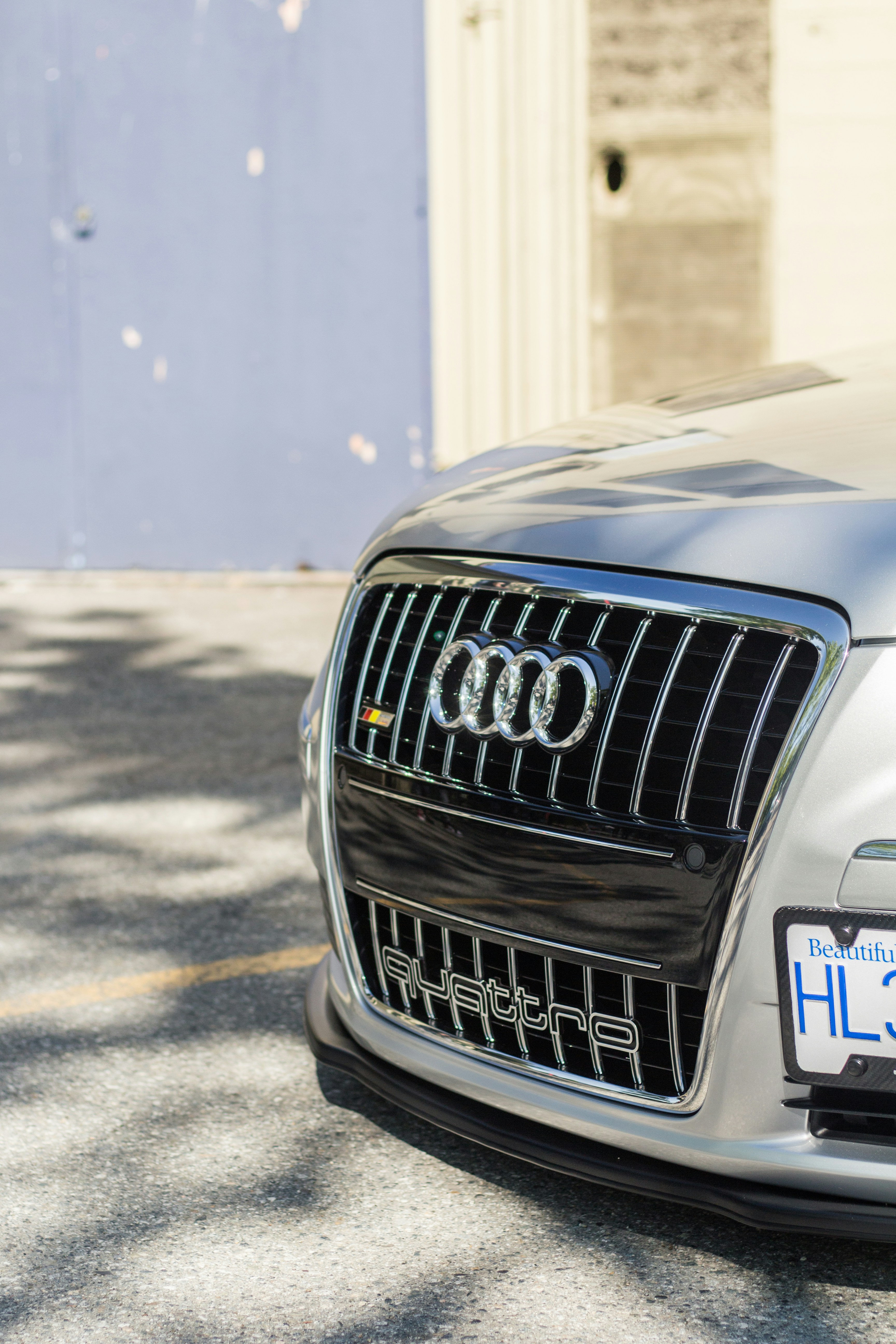 Shiny Audiences: The Audi Emblem Glint at the Car Front