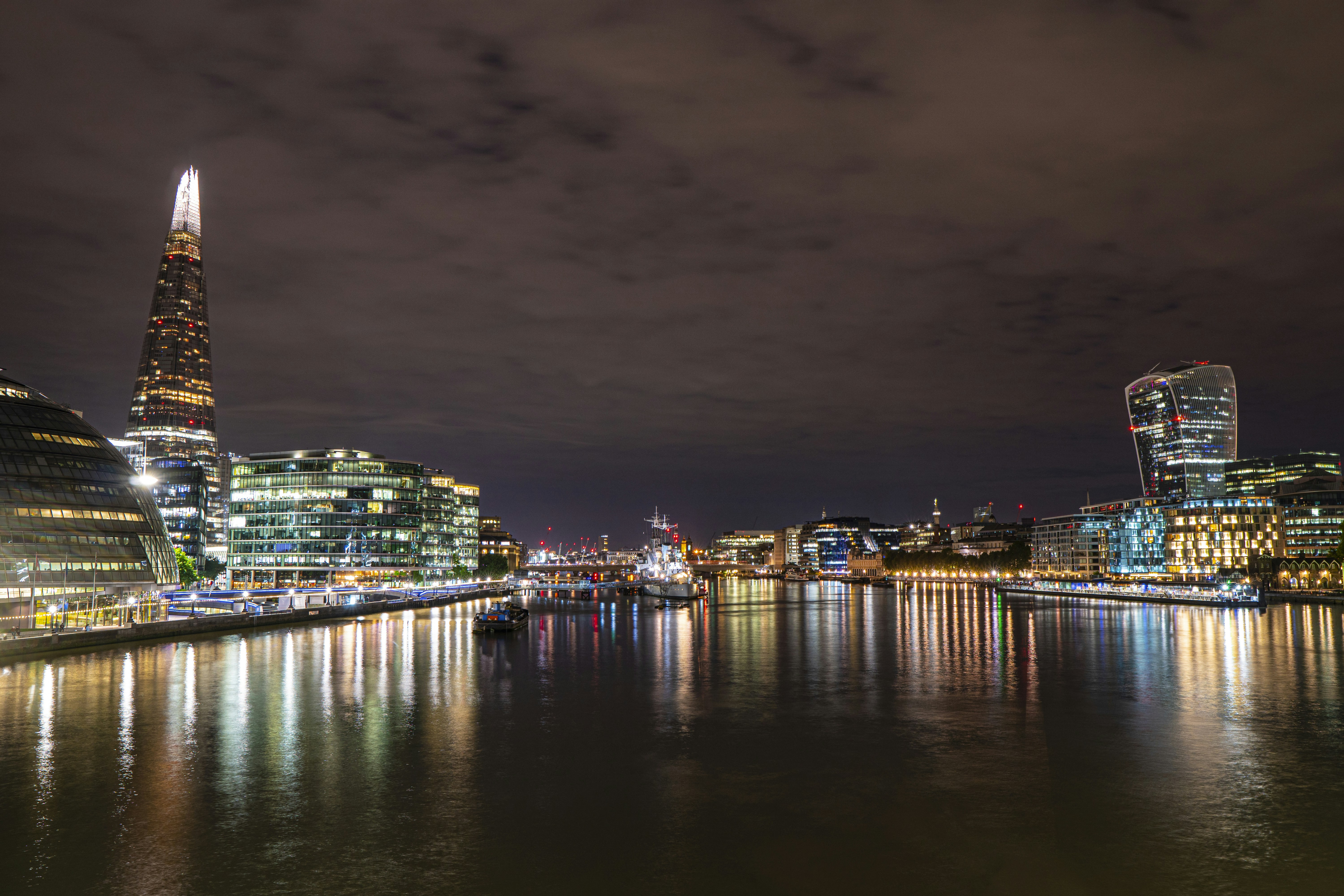 Body of water in between lighted city buildings photo – Free Grey Image ...