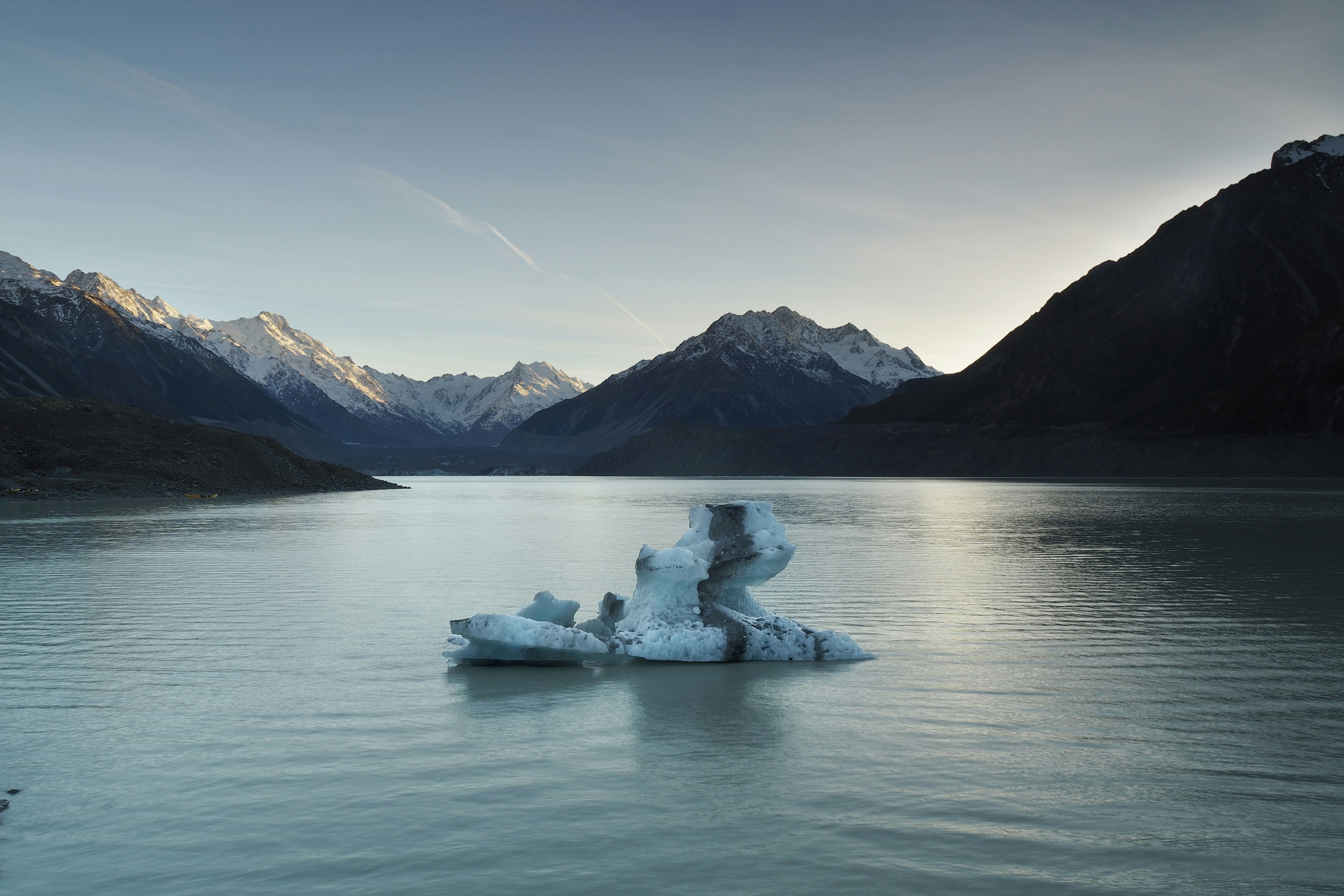 Ice Island in a Quiet Fjord Beneath Snowy Peaks