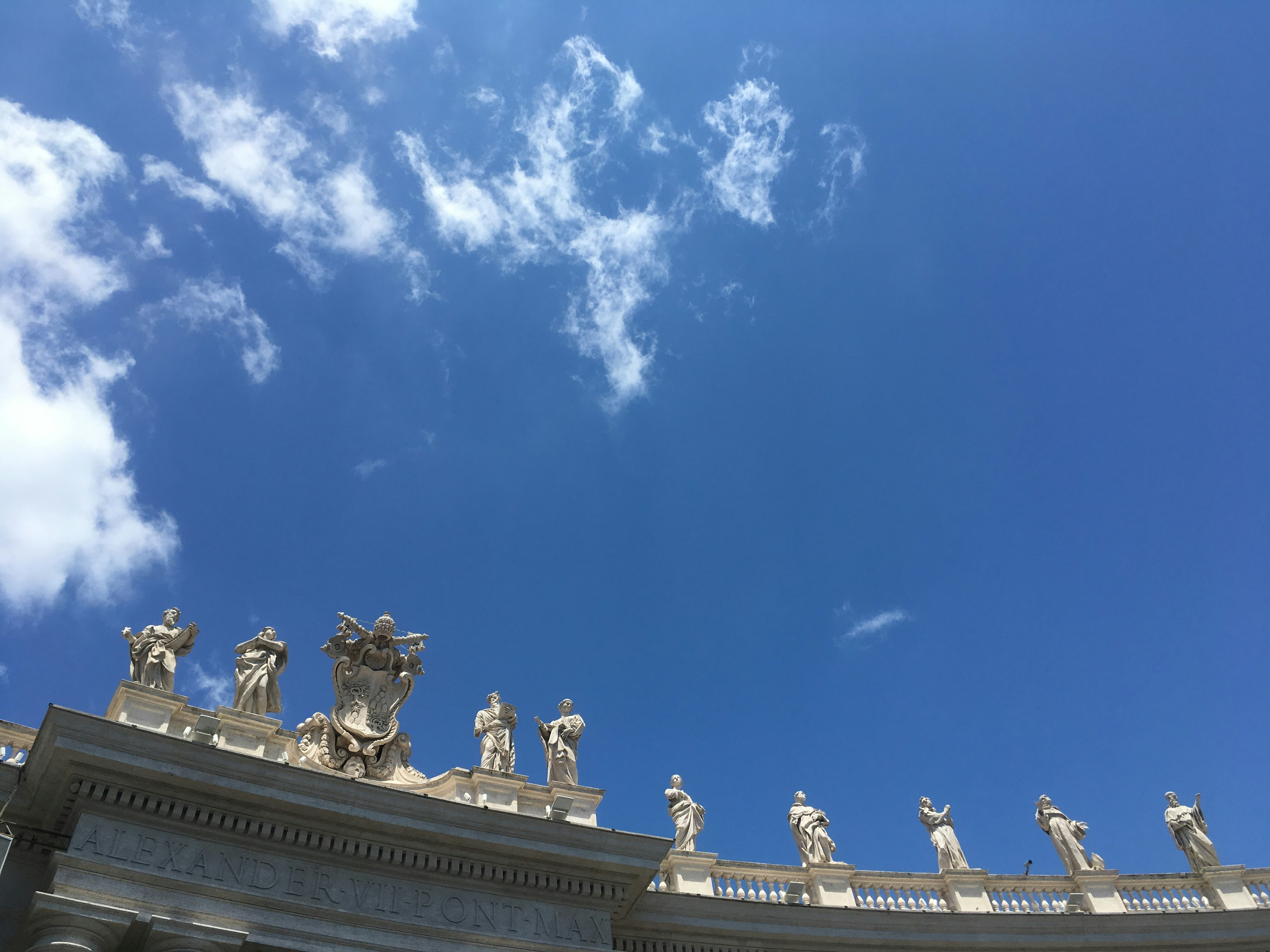 Statues Crown a Classical Terrace Beneath a Brilliant Blue Sky