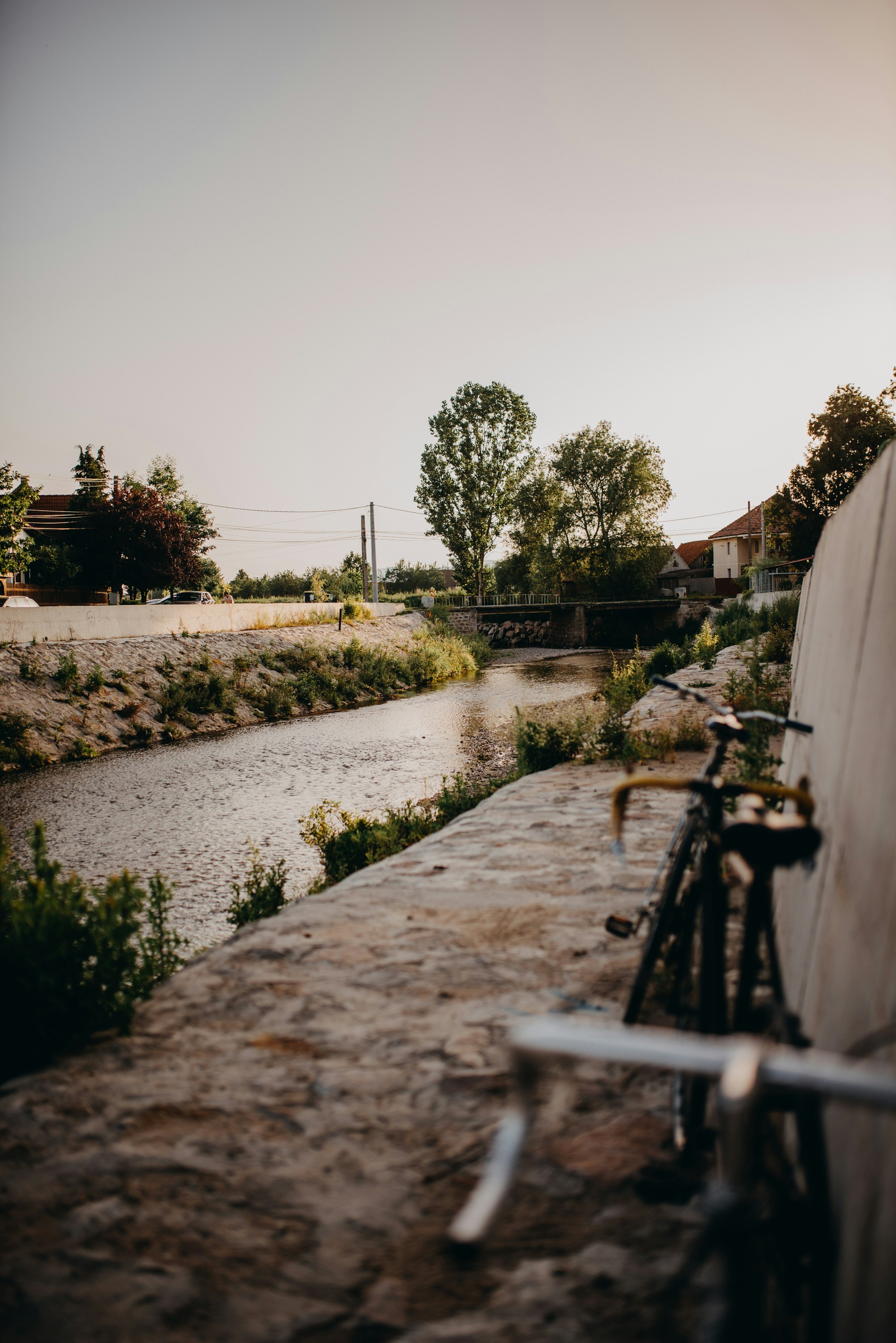Riverside Pathway: A Quiet Scene with a Leaning Bicycle