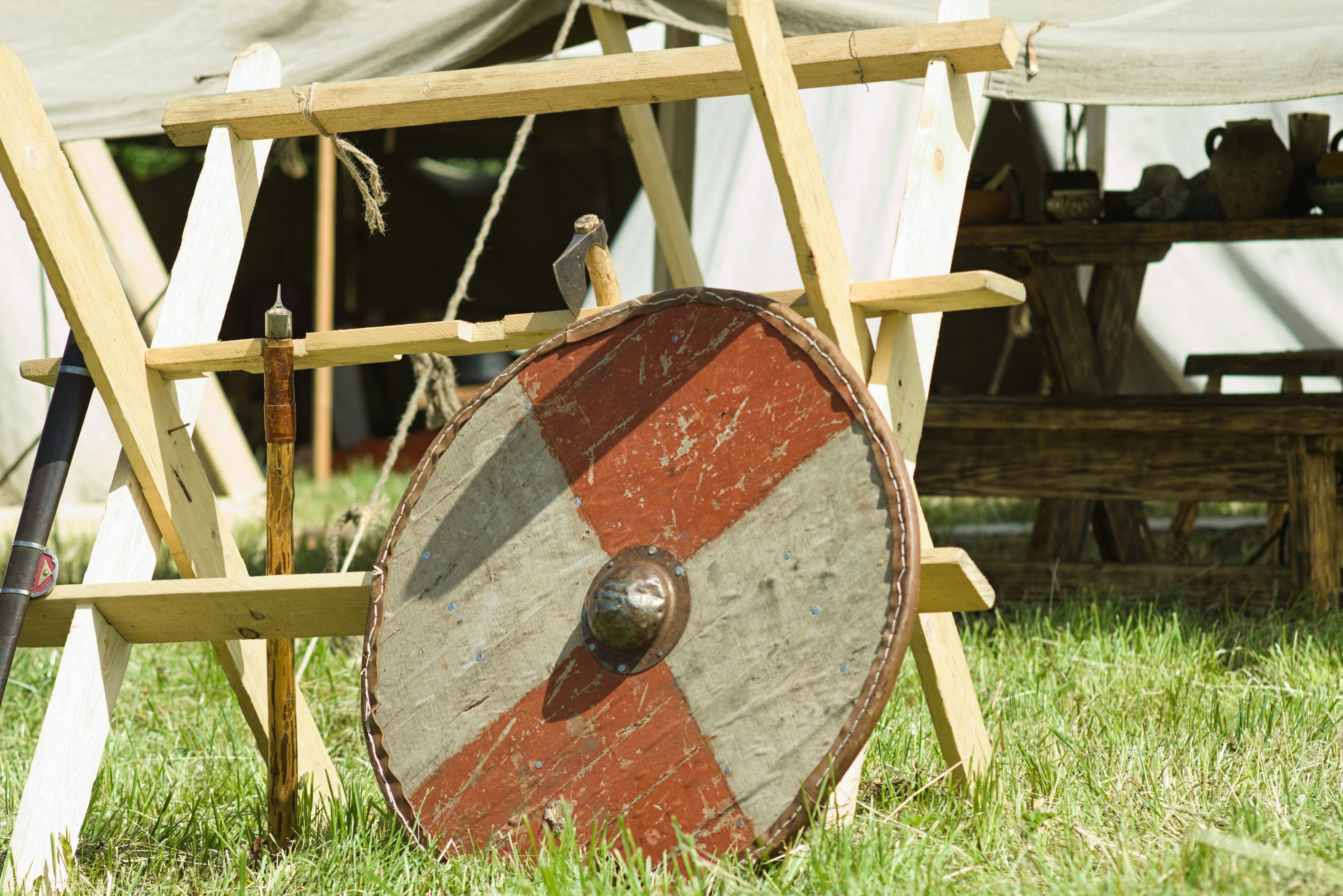 round brown and gray shield leaned on brown wooden rack