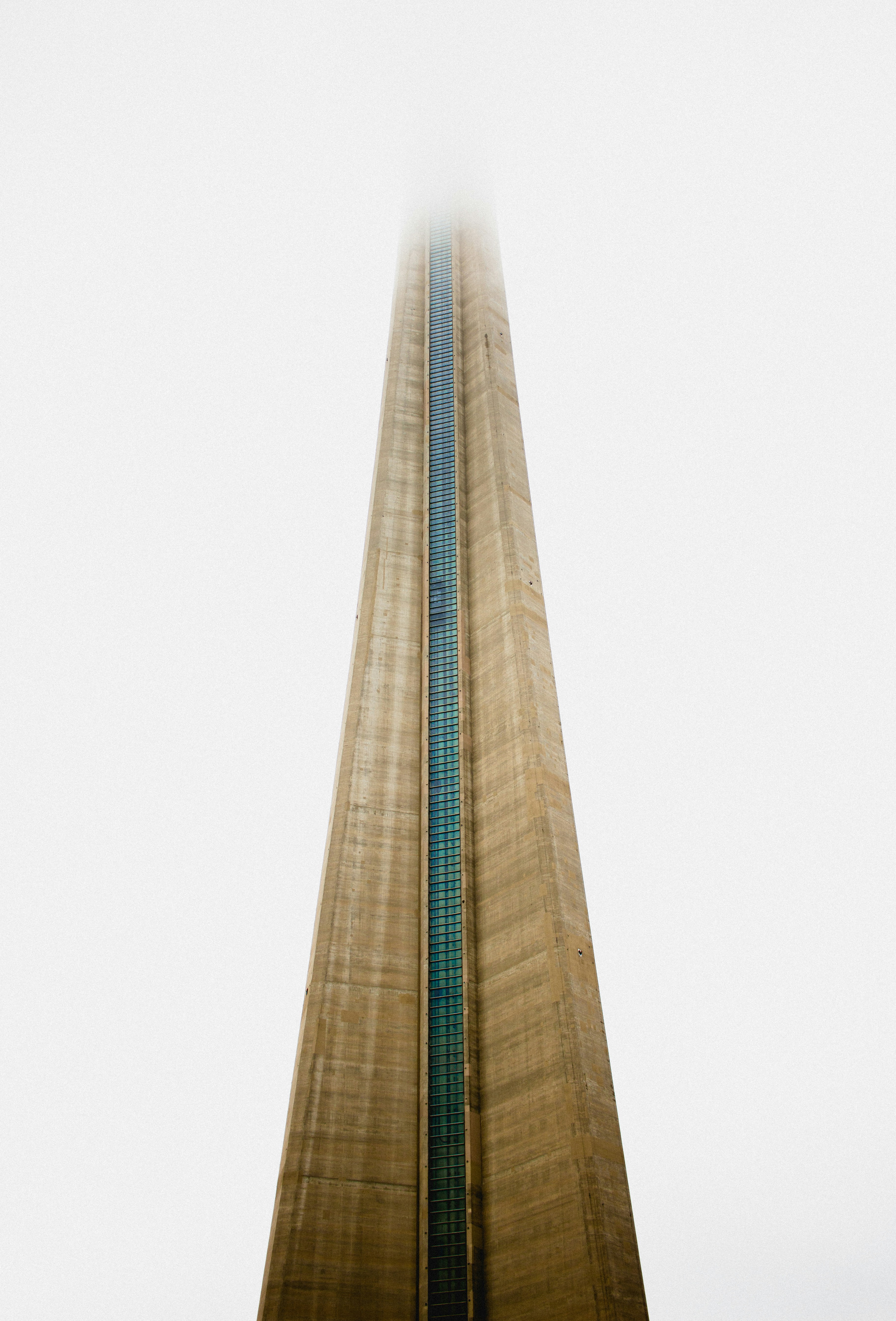 Spire Through the Mist: A Blue-Cored Wooden Monolith
