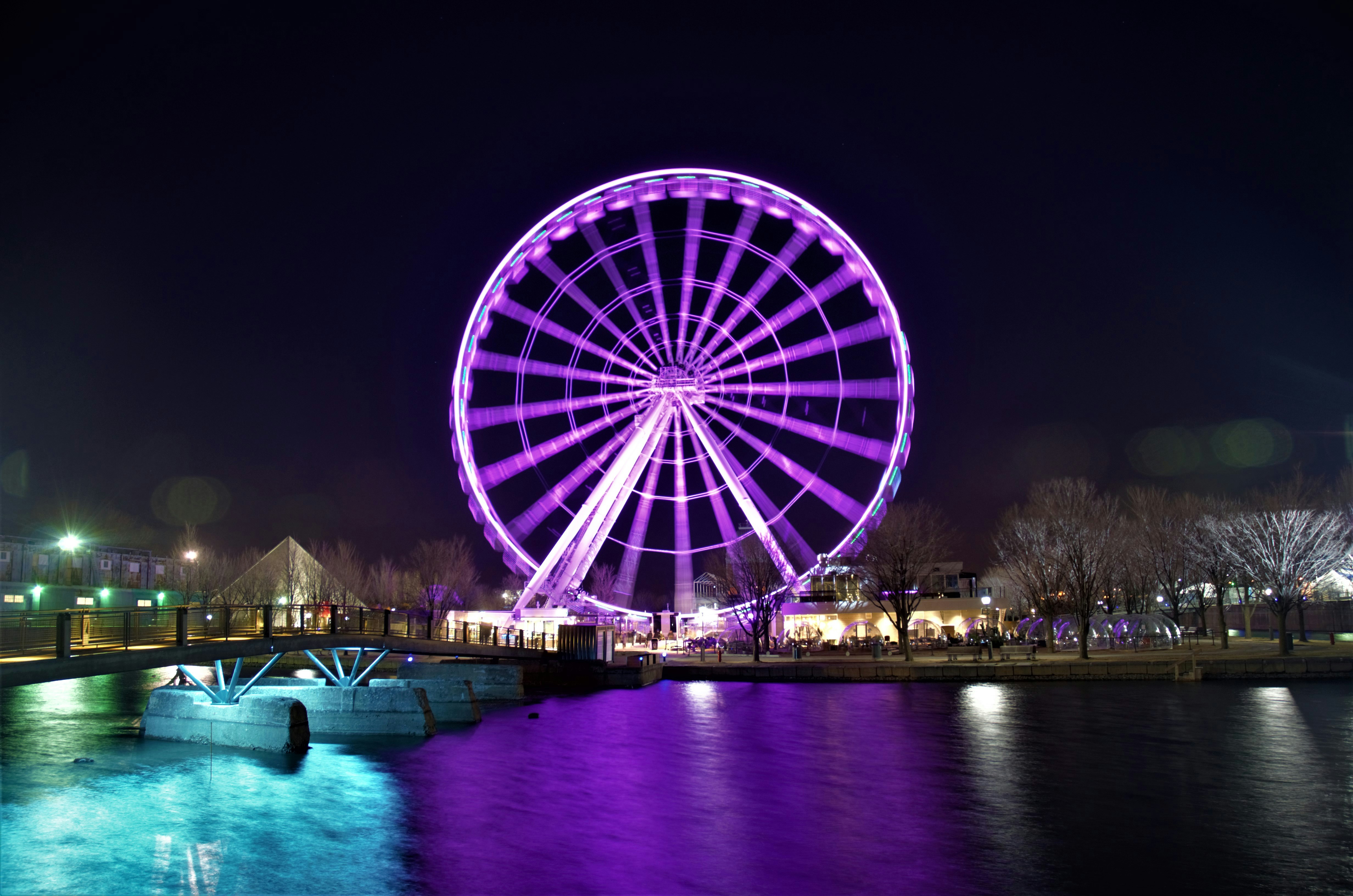 Neon Wheel of Night: A Giant Ferris Wheel Glows Over the Waterfront