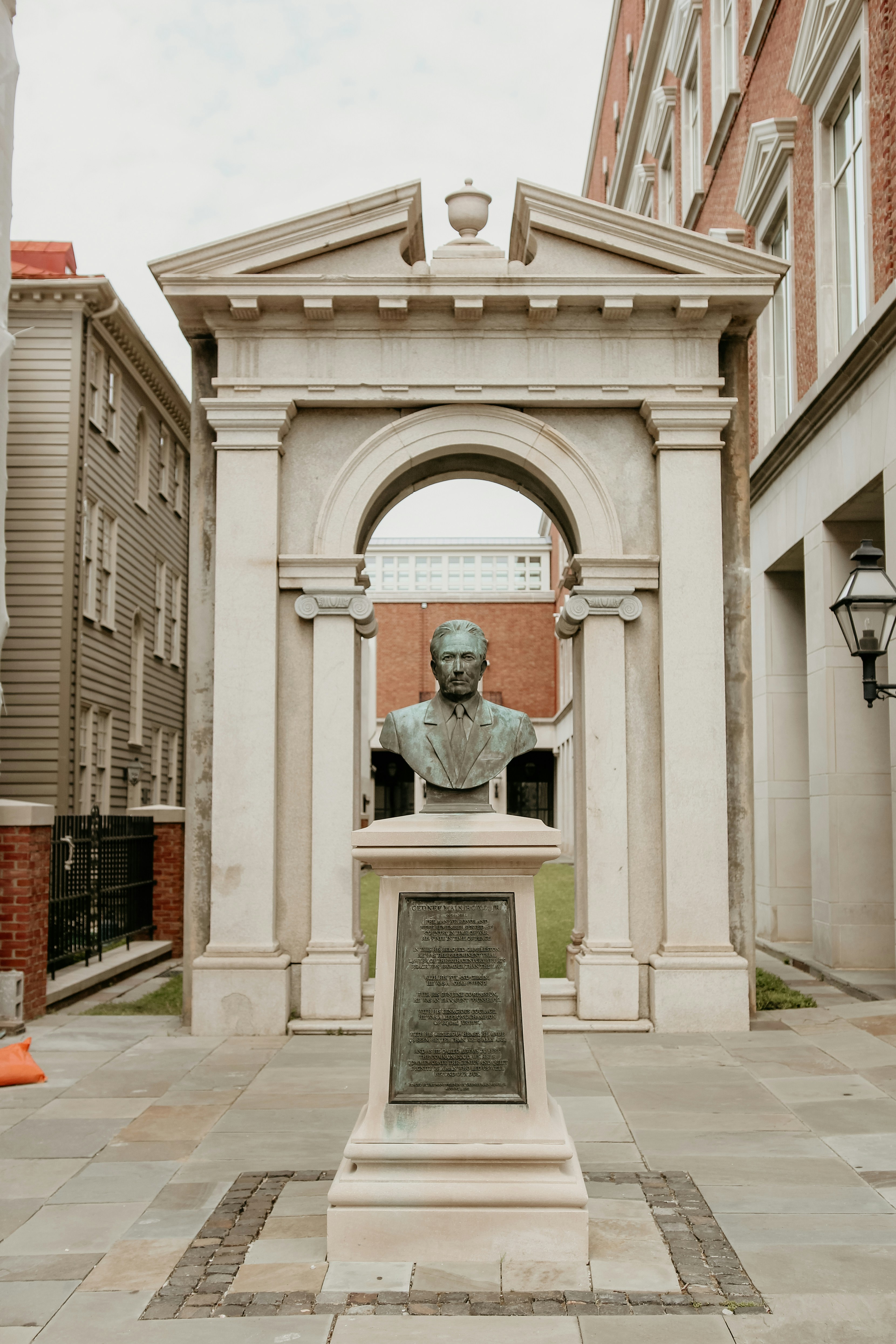 Archway Portrait: The Bust Framed by Stone Geometry in a Collegiate Courtyard