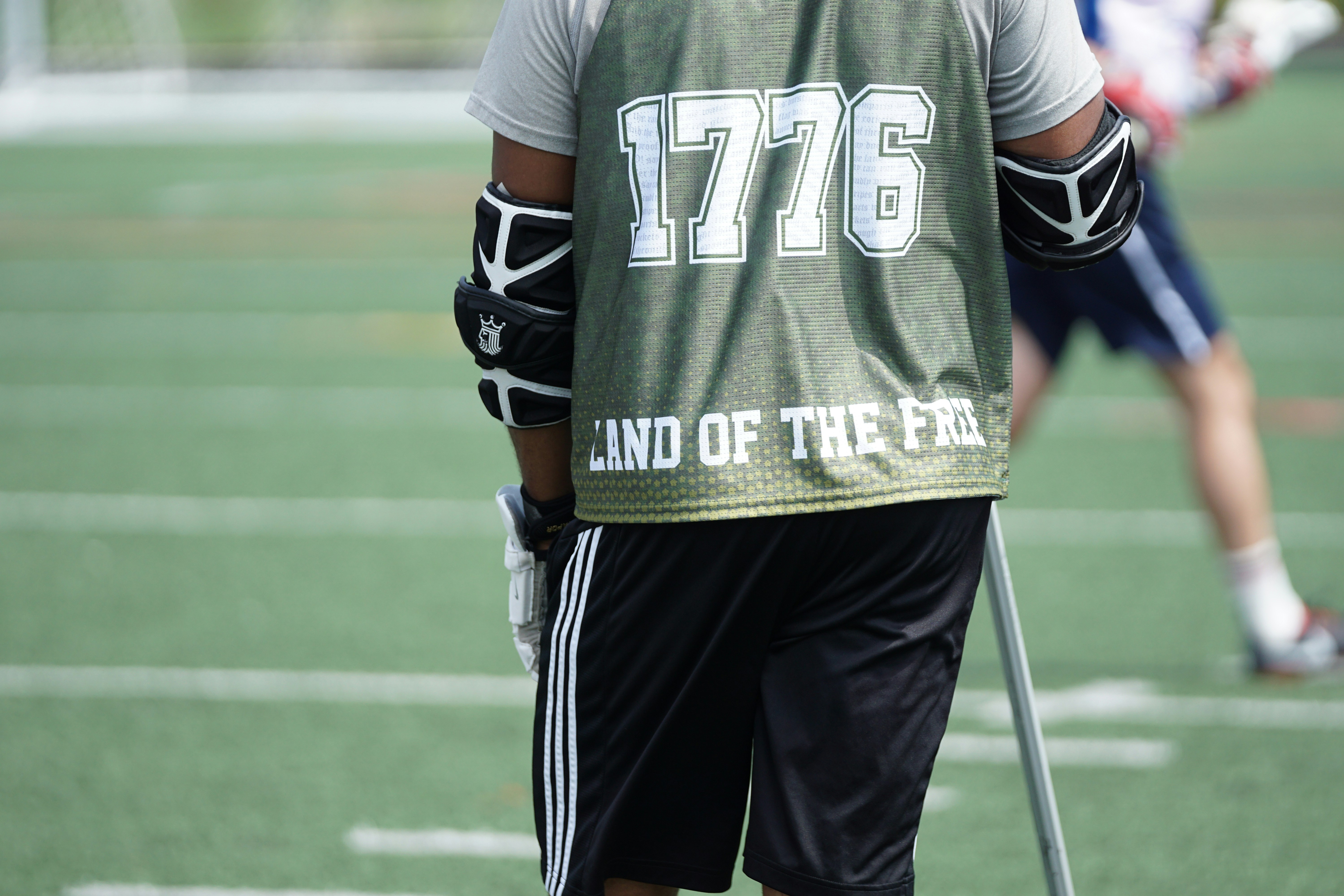 Center Field: The Player in Green with Crisscrossed Night-Knock Straps