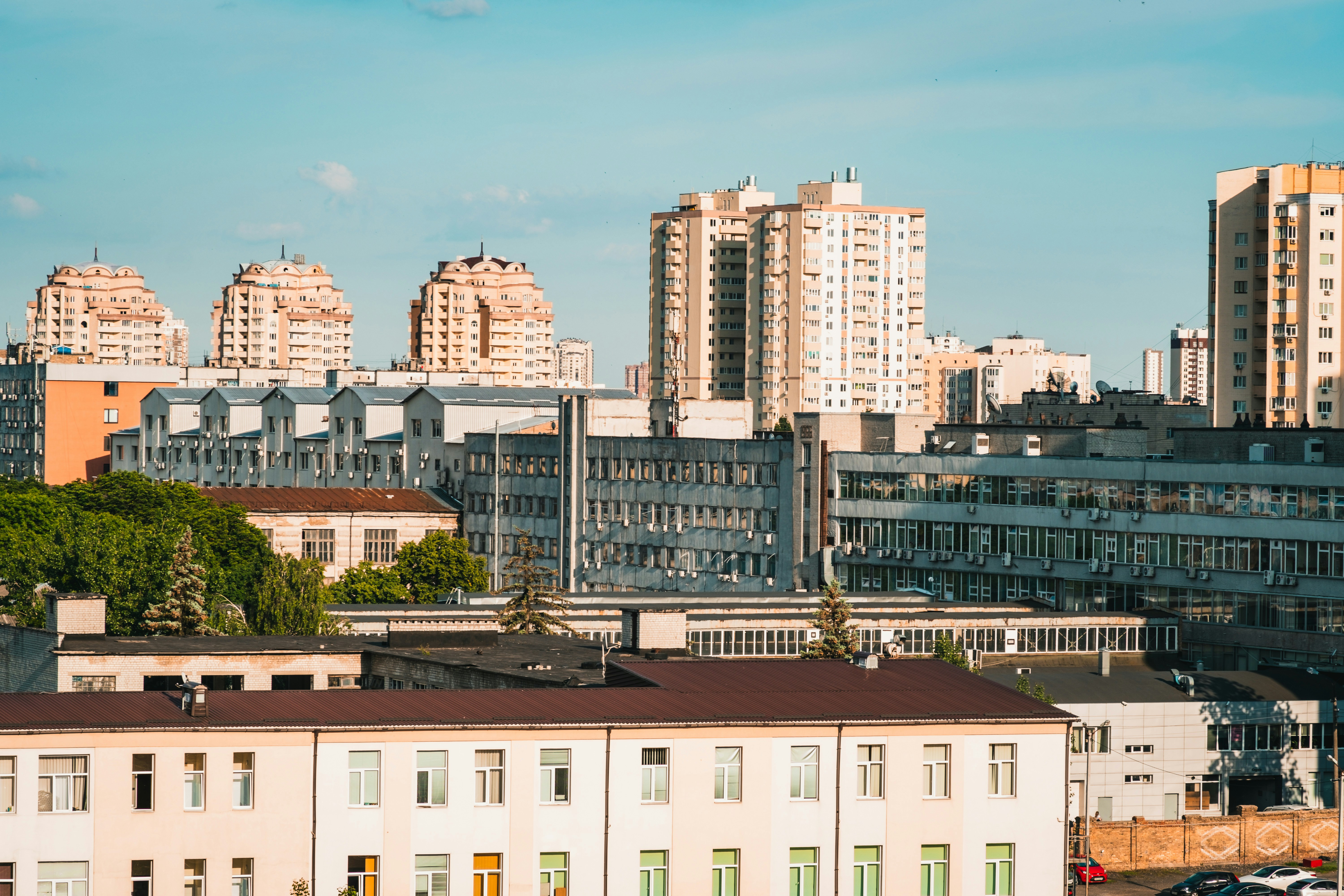High-rise buildings under a clear blue sky with geometric precision.