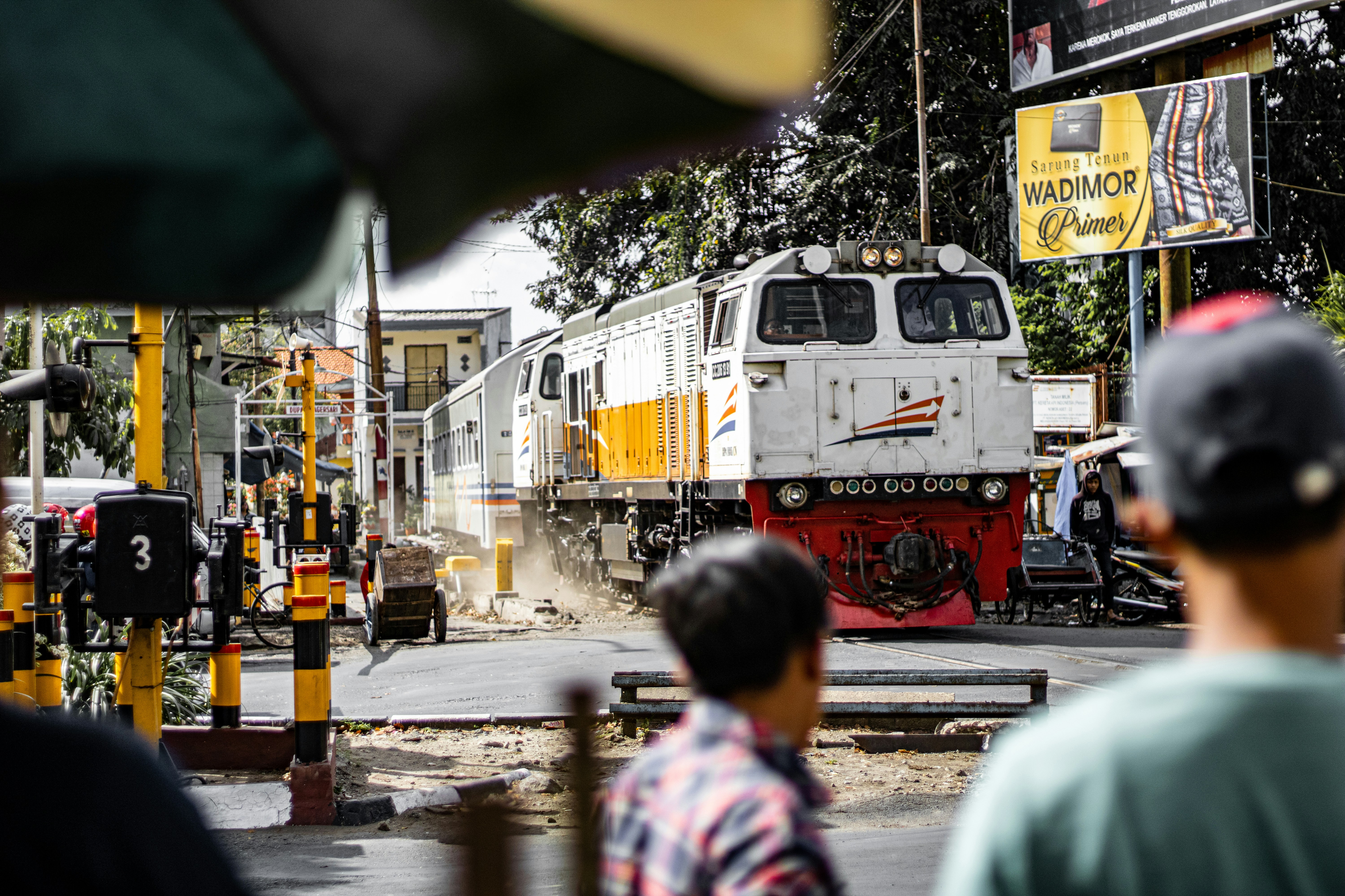 Diesel Dawn: Train Rumbles Through a Busy Street