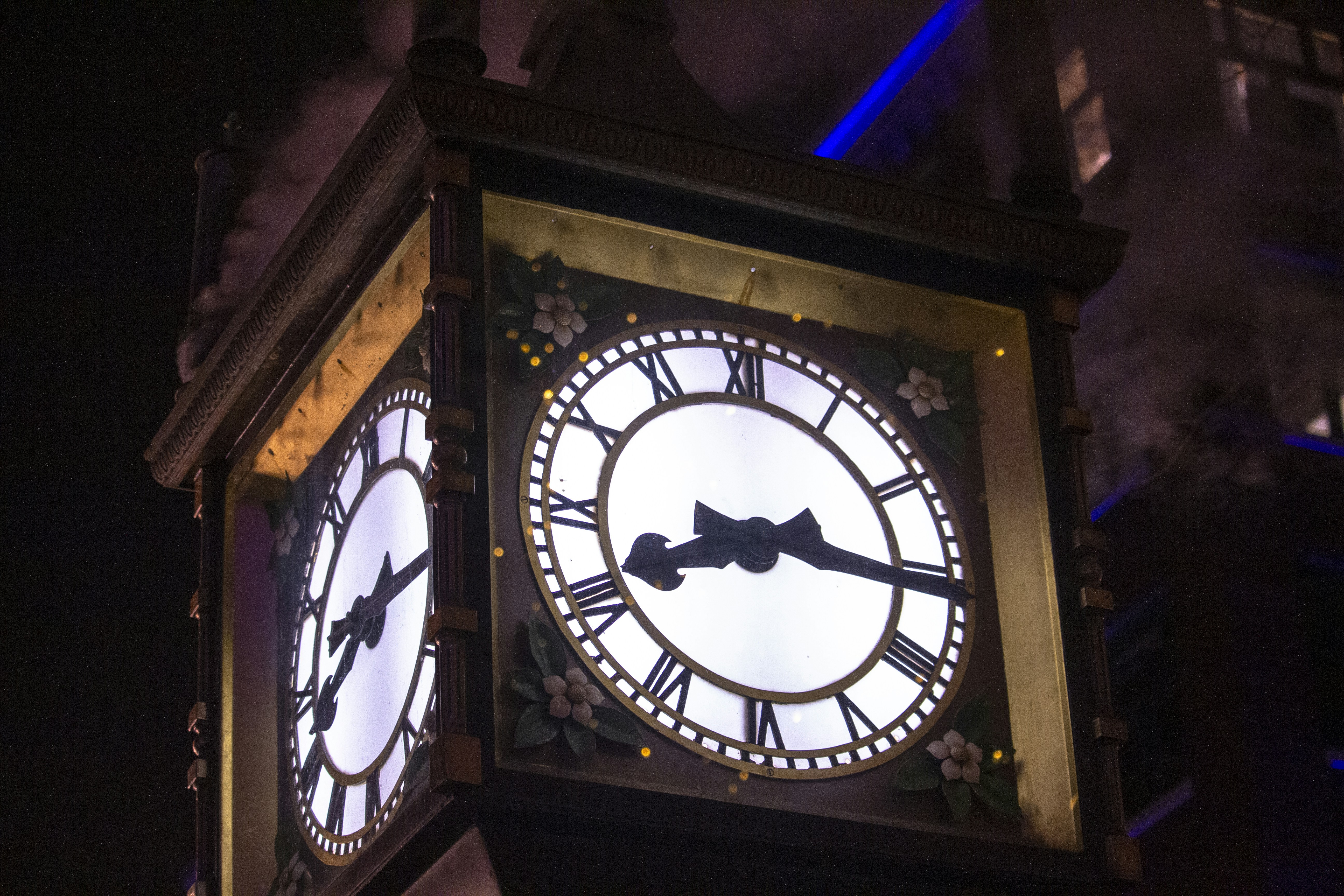 Moonlit Carillon: Close-Up of a Floral-Framed Clock Tower Dial