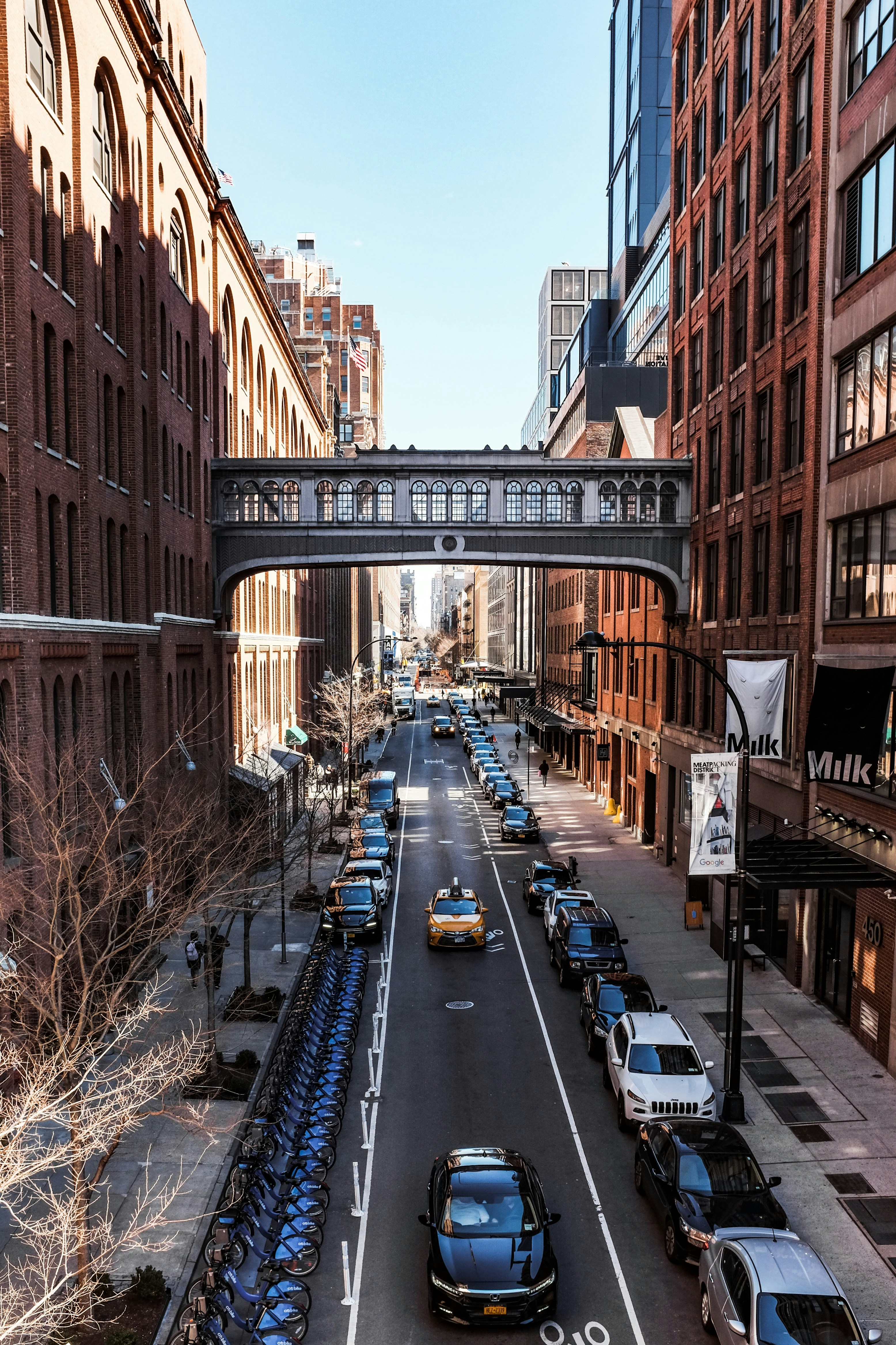 Under the Steel Arch: A City Street's Narrow Perspective