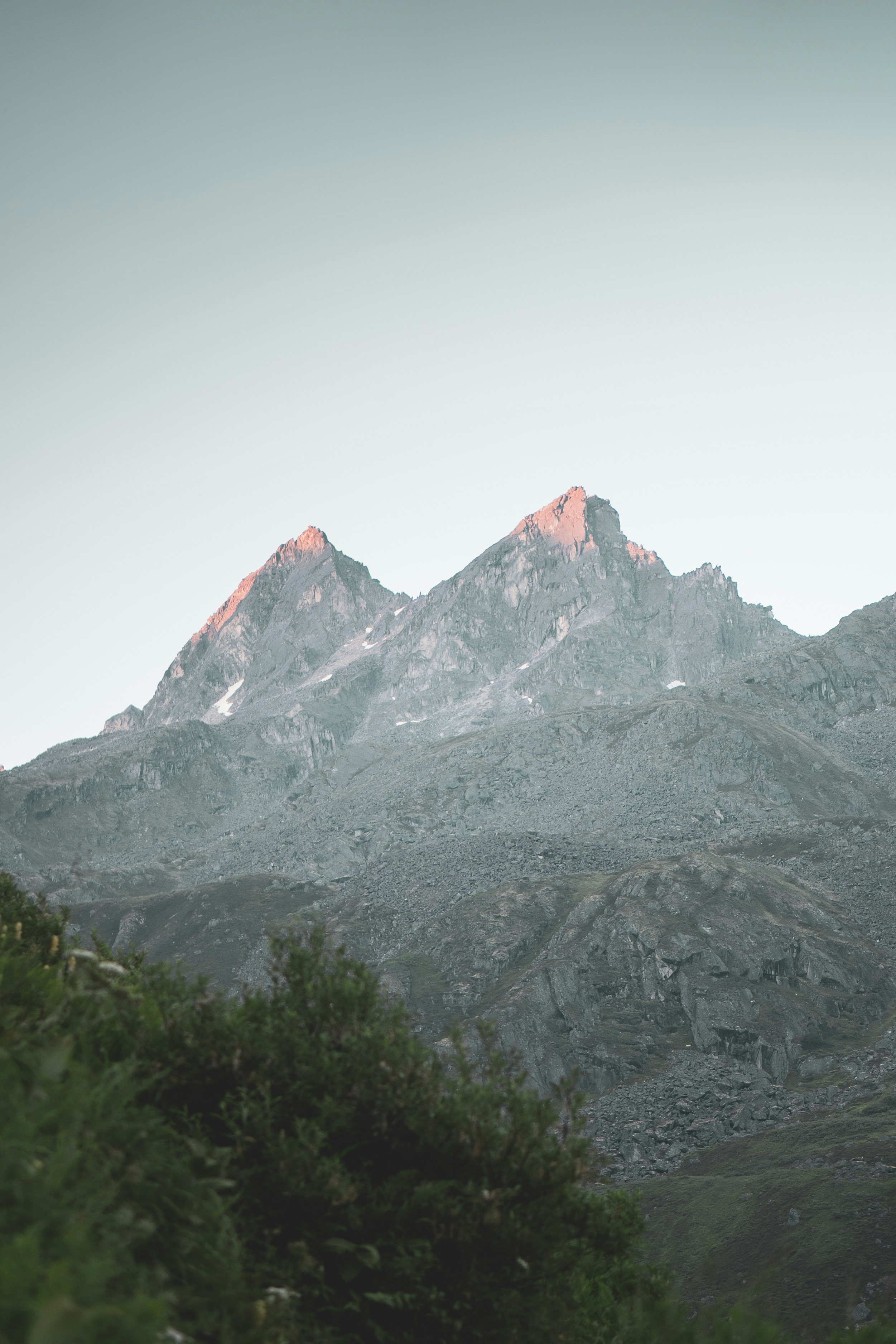 Rose-tinted Peaks Beneath a Pale Sky