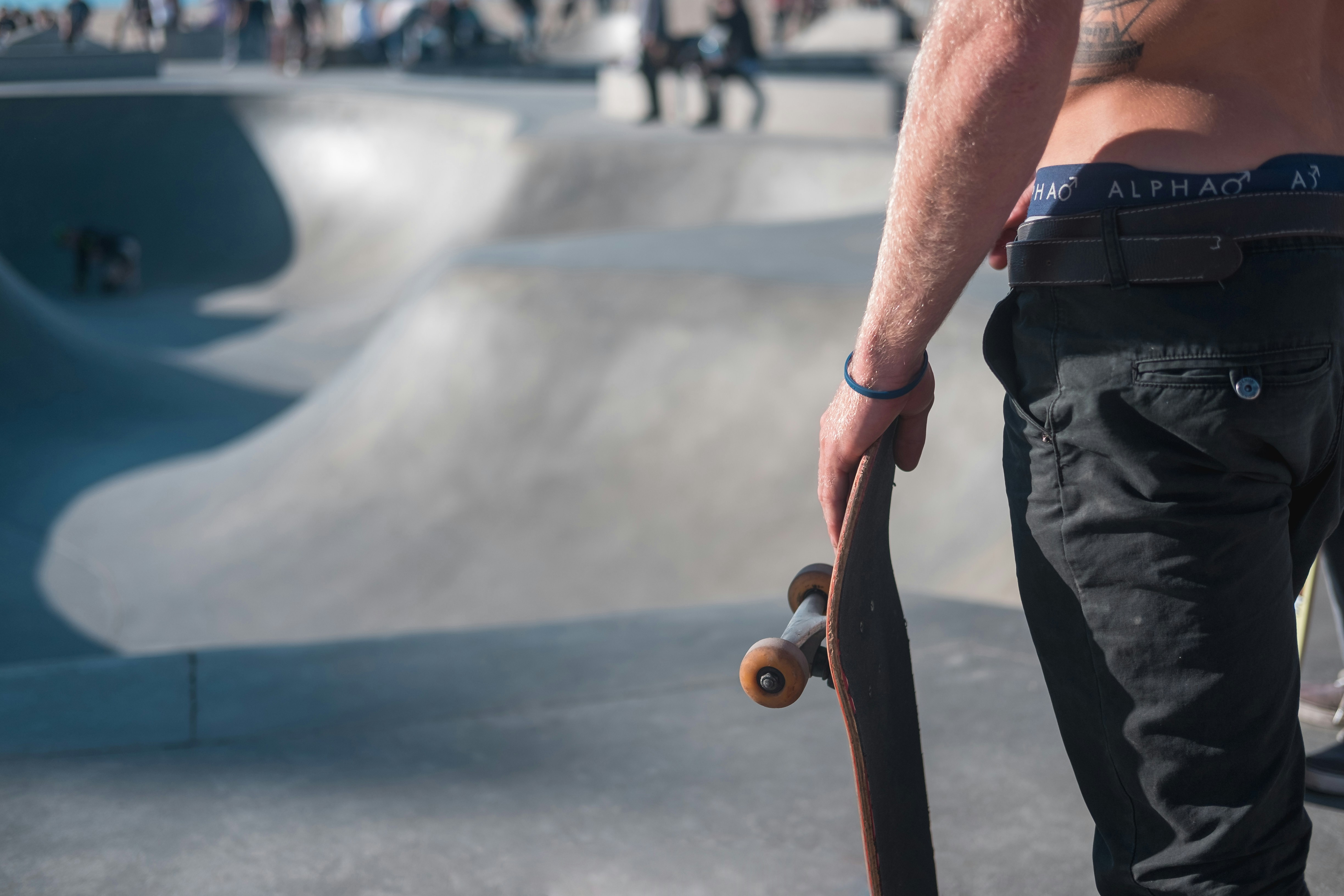Shallow focus photo of person holding black skateboard photo – Free ...