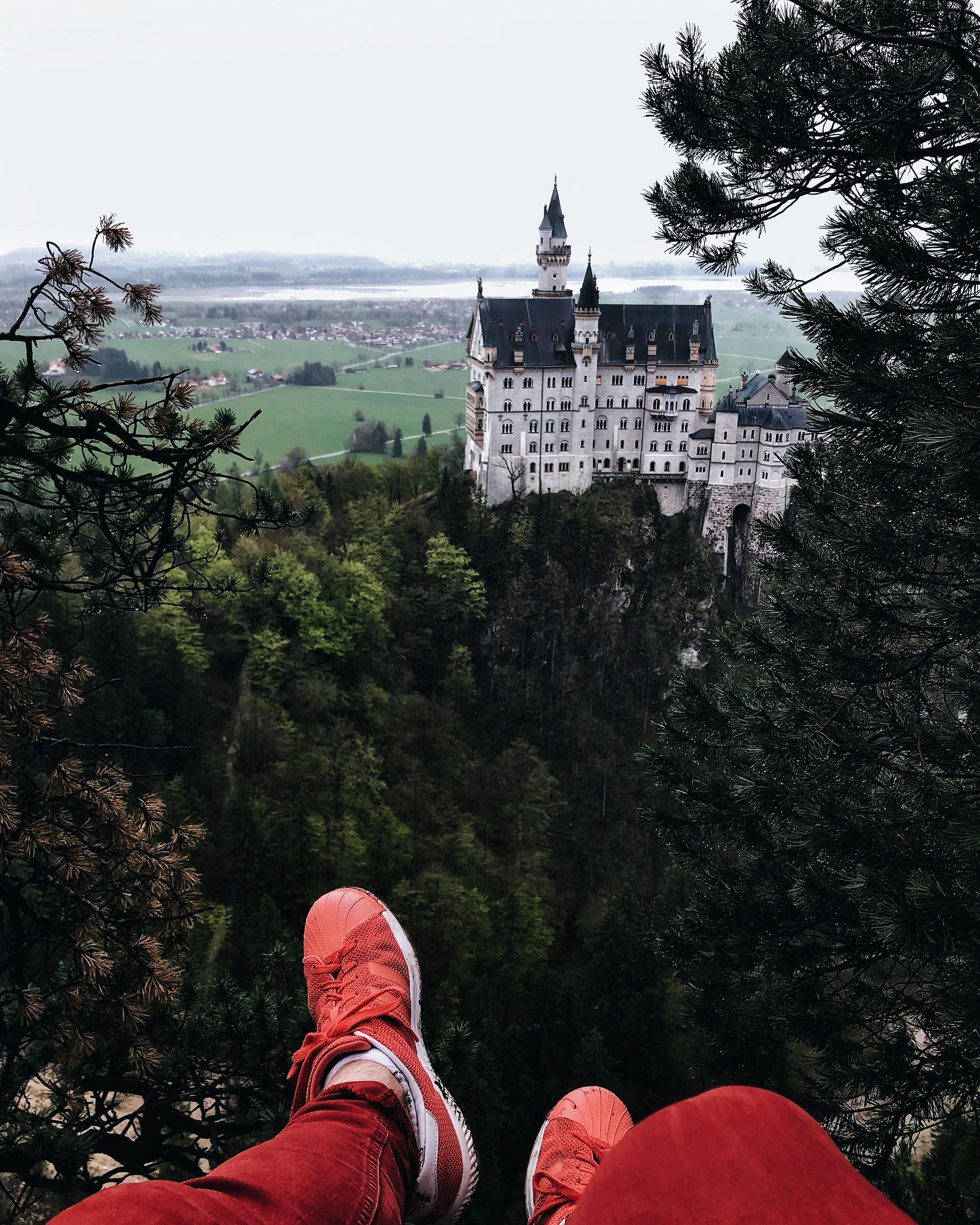 Red Shoes Over the Pines: A Bavarian Castle Revealed Through the Forest