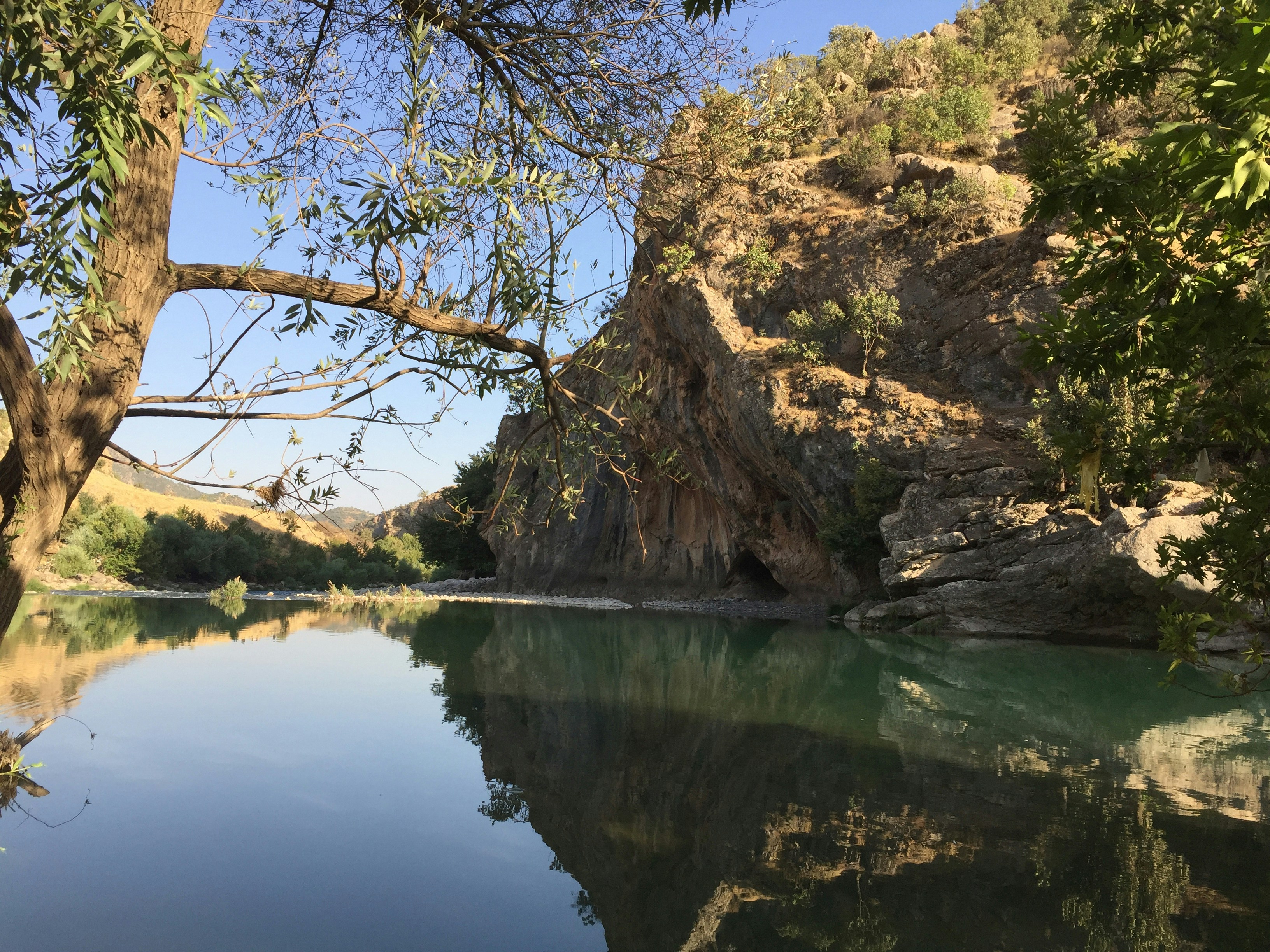 Reflection of rocks on water photo – Free Nature Image on Unsplash