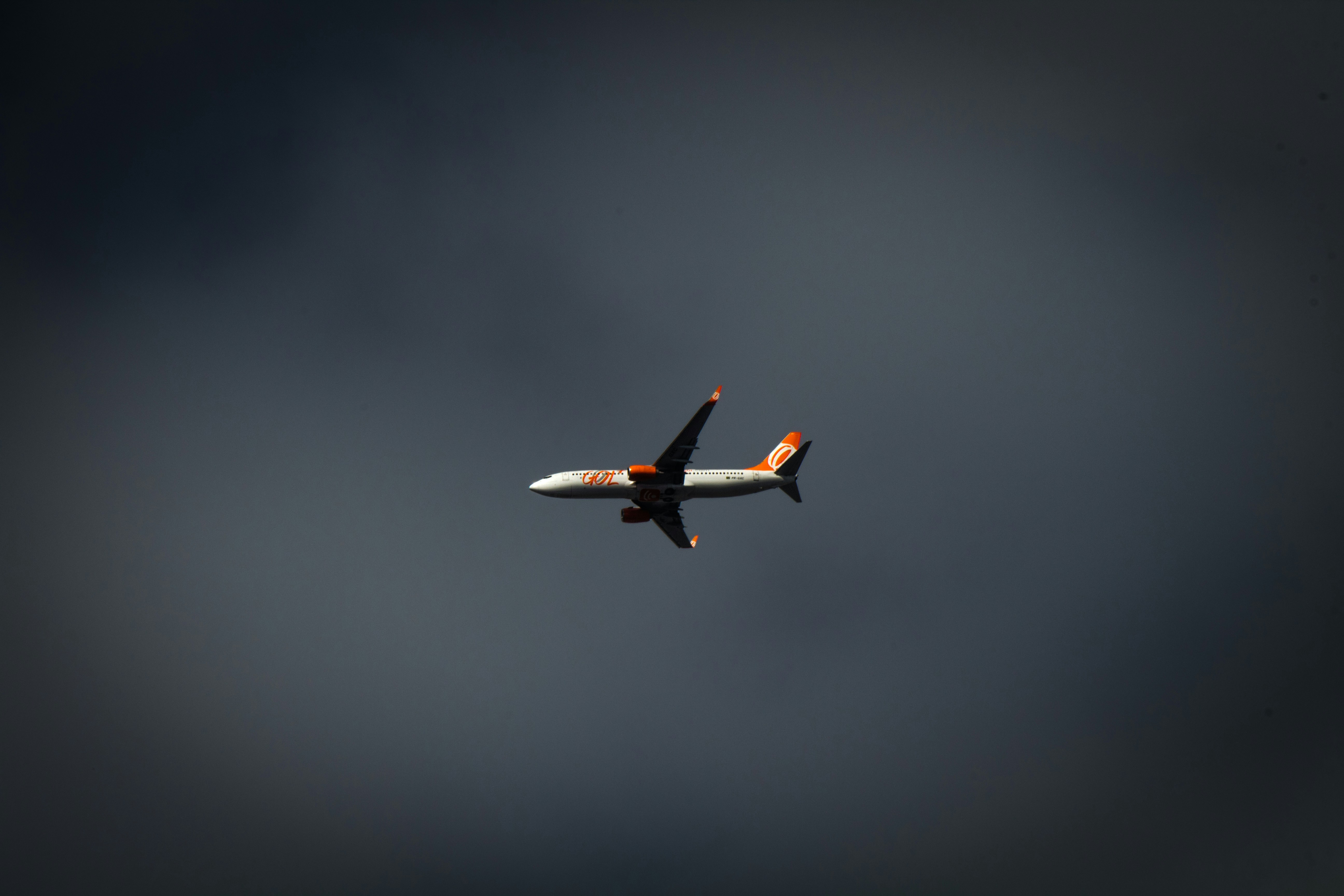 Orange-tipped Jet Through a Moody Dusk