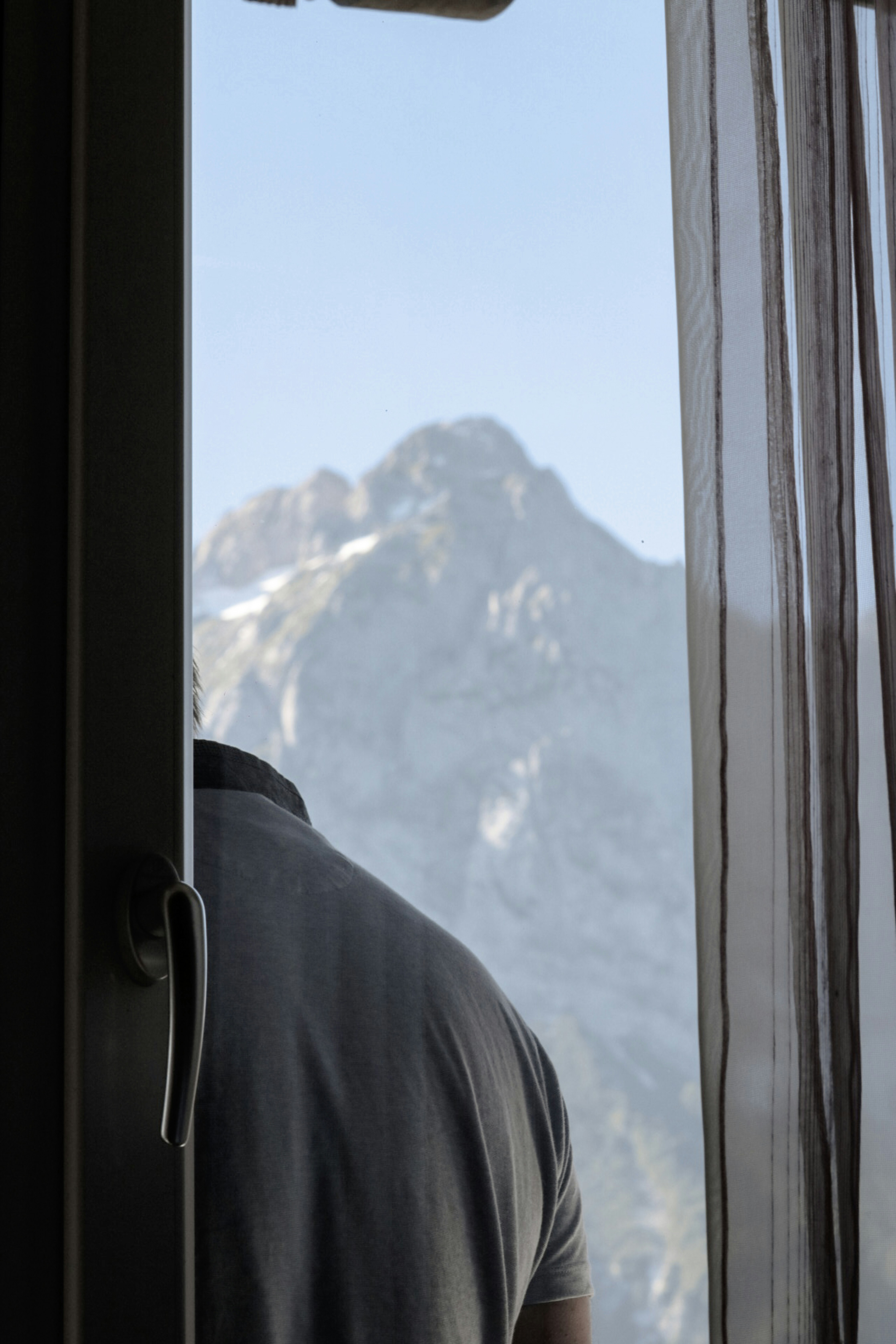 Person standing beside glass door photo – Free Blue Image on Unsplash