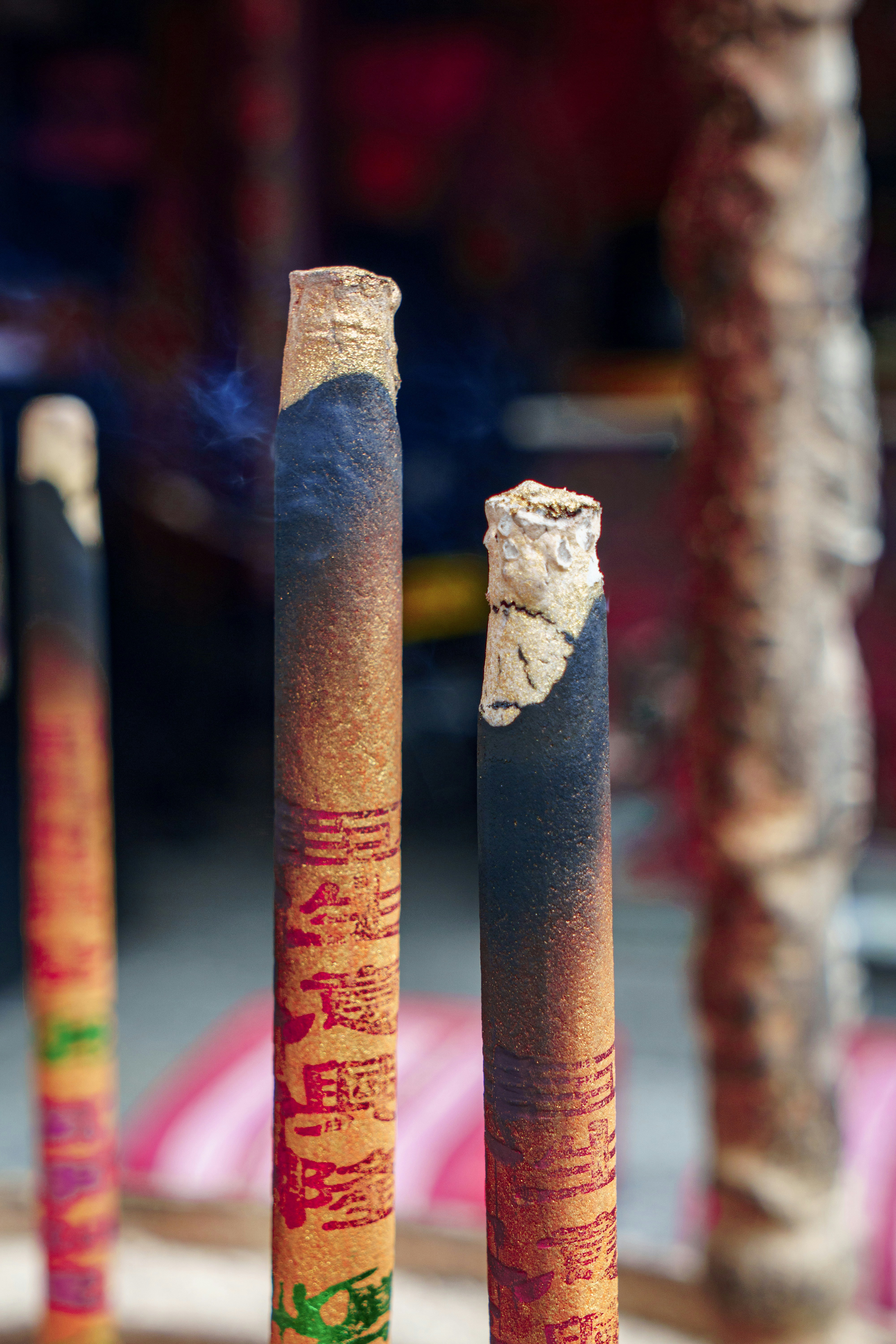 Ash-Streaked Incense Sticks in a Quiet Shrine