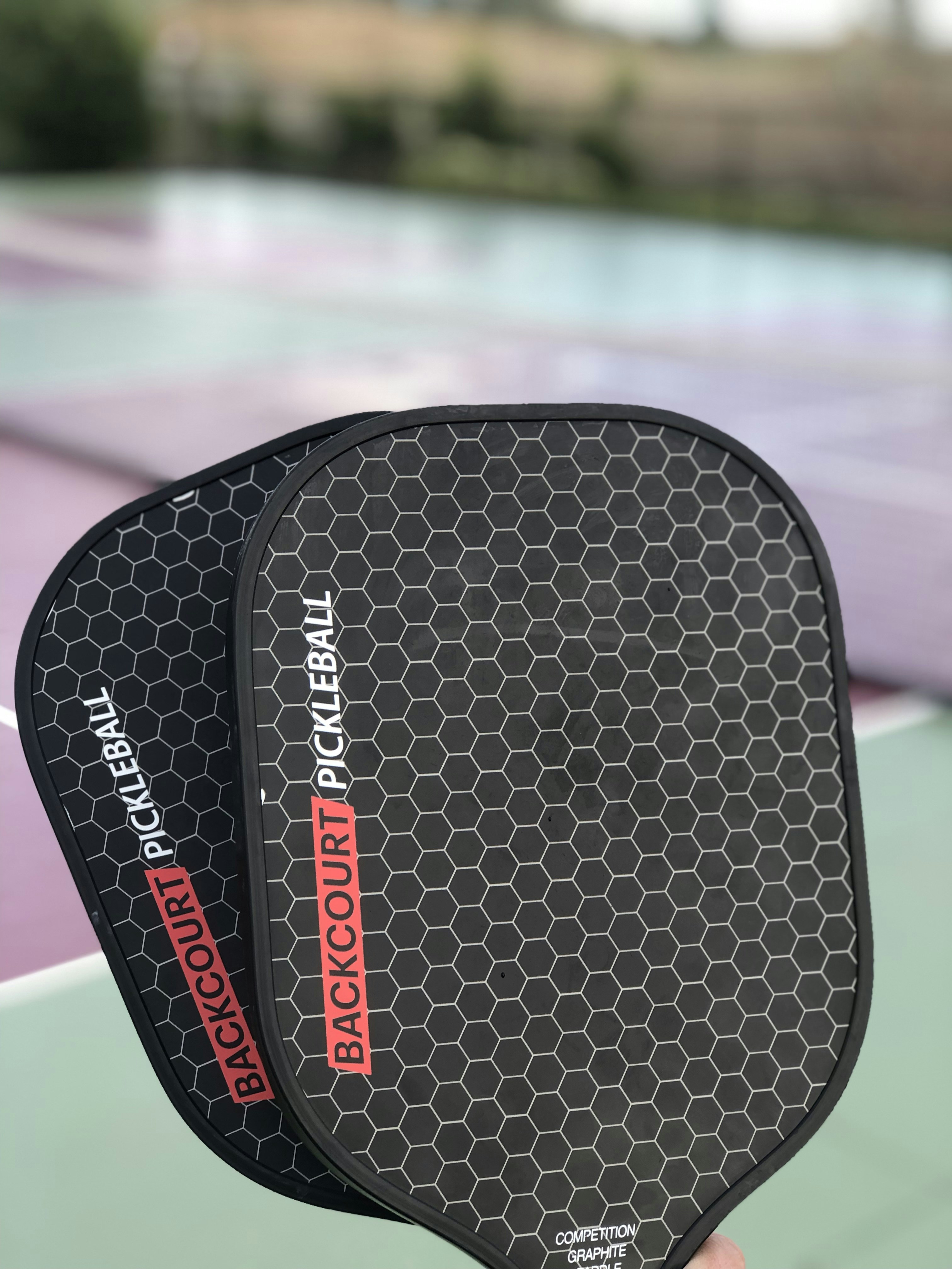 Hex-Patterned Paddle Duo: Close-Up on Pickleball Gear