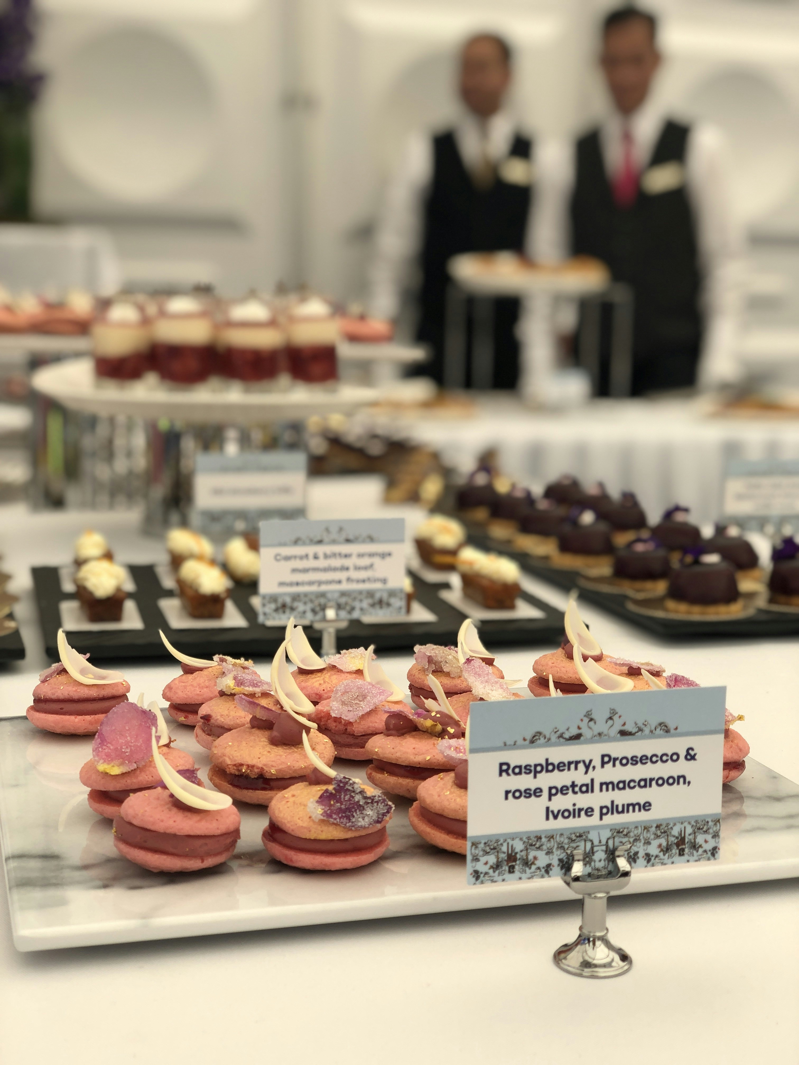 Raspberry Prosecco Rose Macarons on a Gleaming Dessert Display