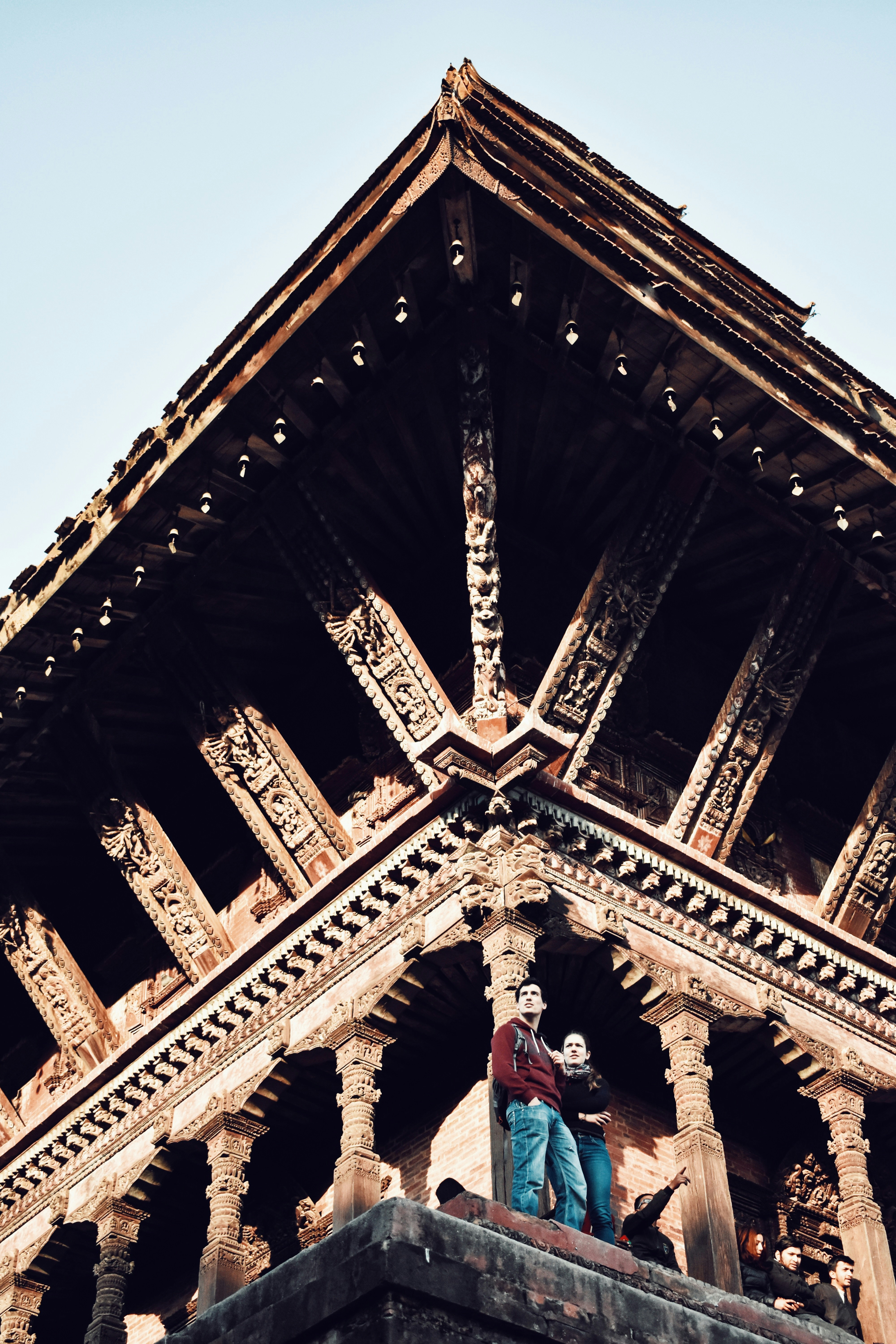 Timber Lace and Balcony Moment Under an Ornate Temple Gable