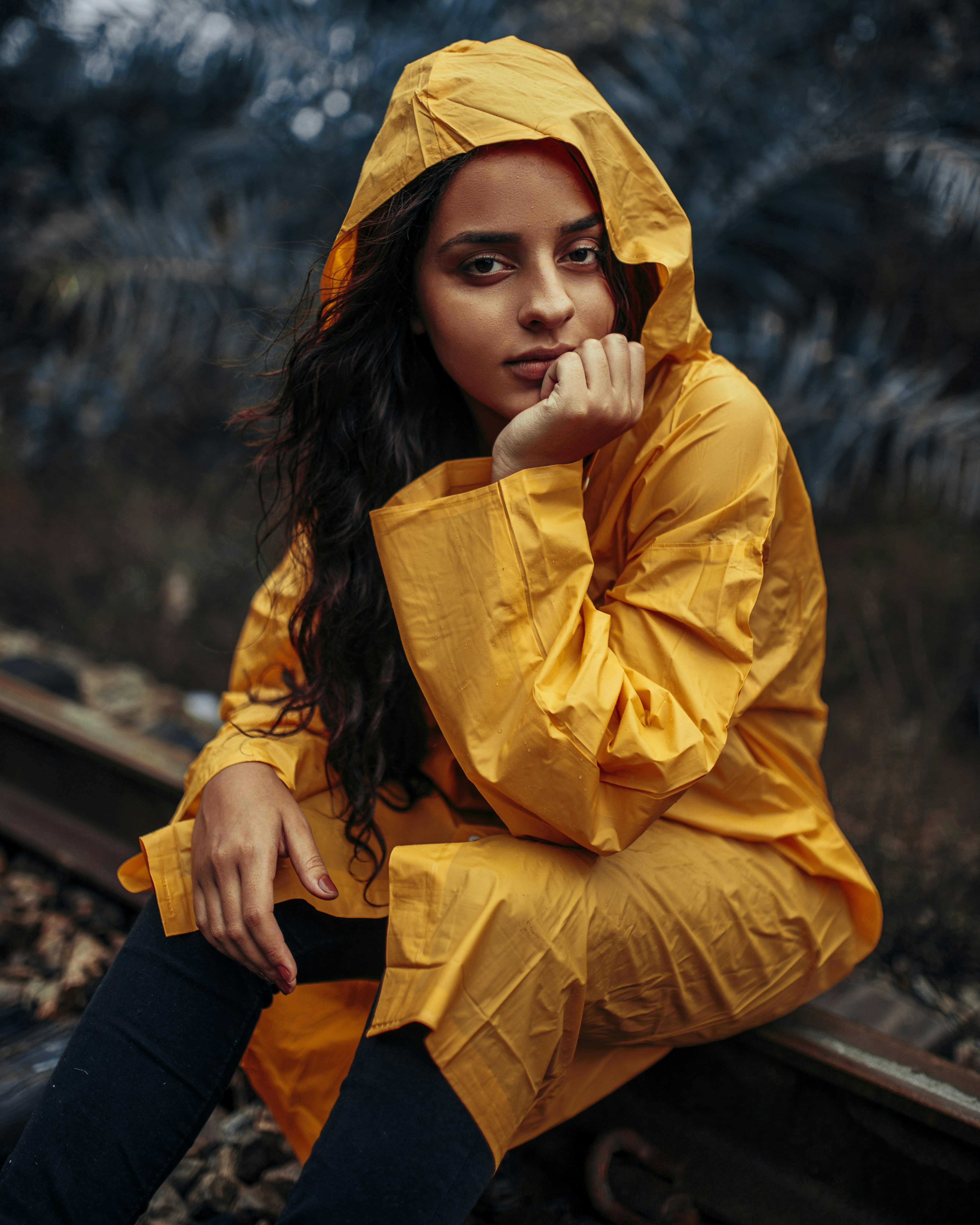 Amber Raincoat Quietude: A Portrait on Rusted Rails