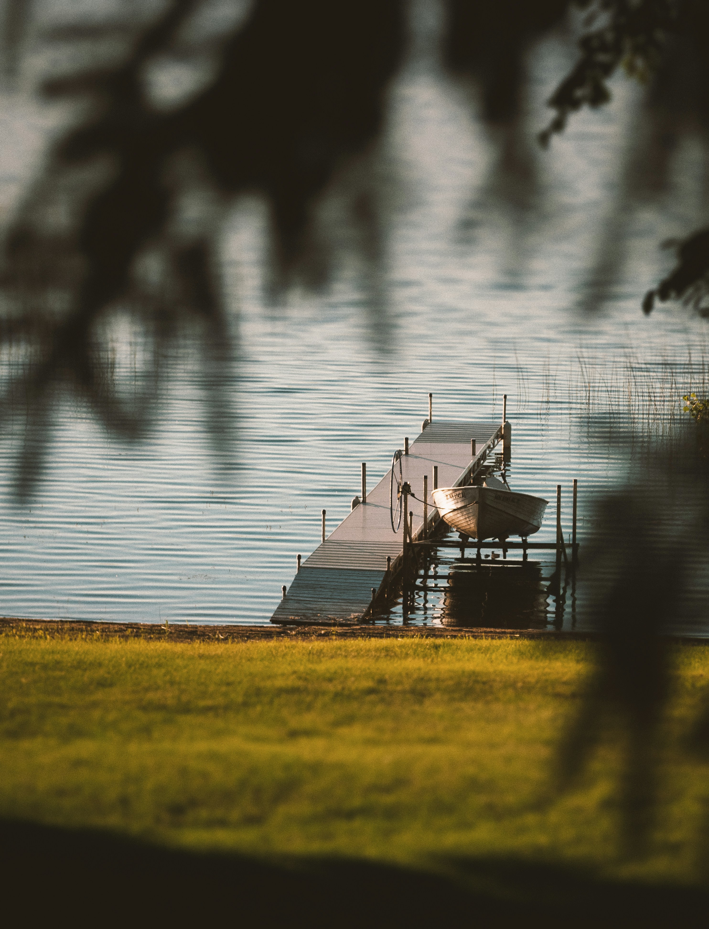 End of the Quiet Dock: a Boat Resting on Golden Lake