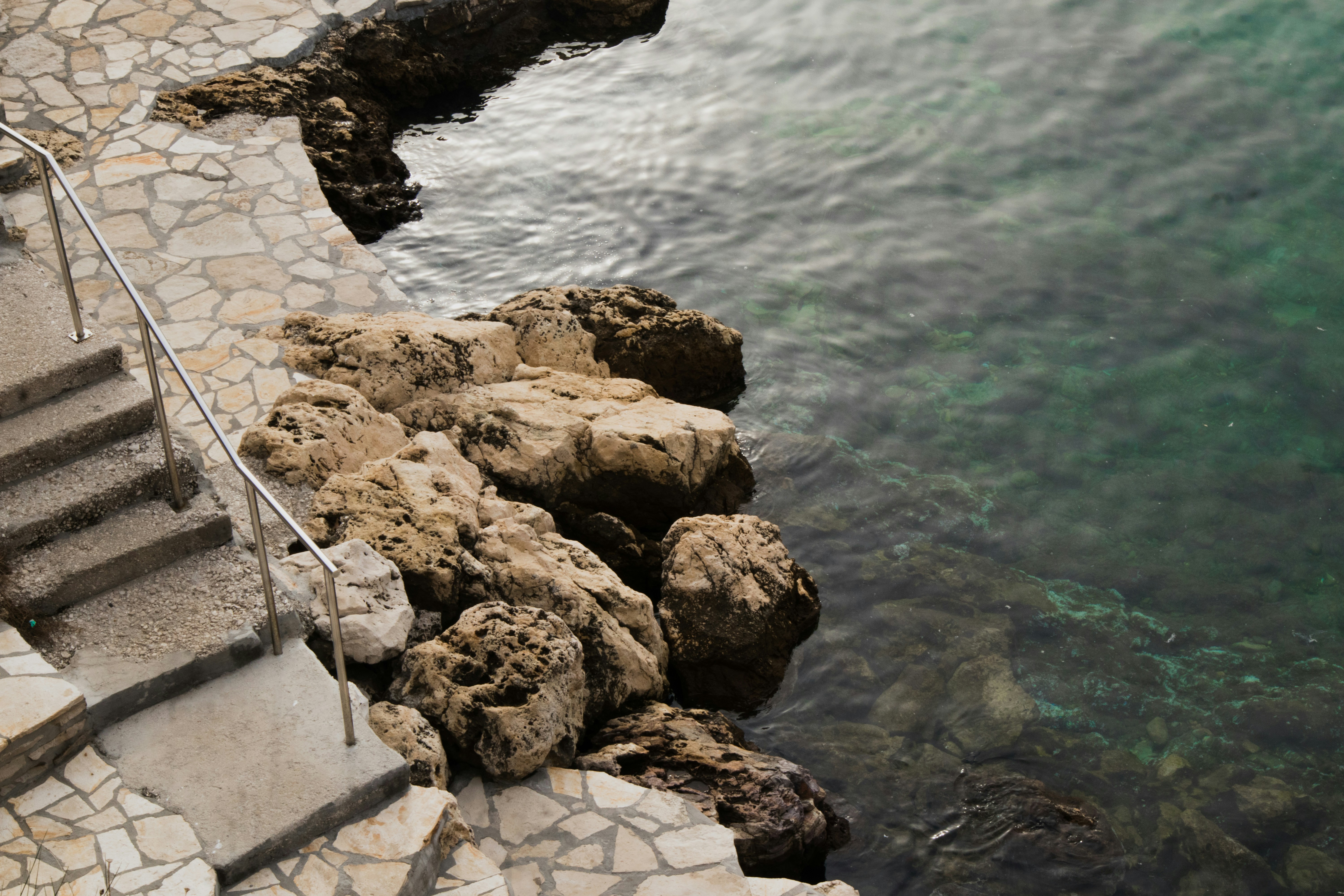 aerial photography of stairway beside body of water during daytime