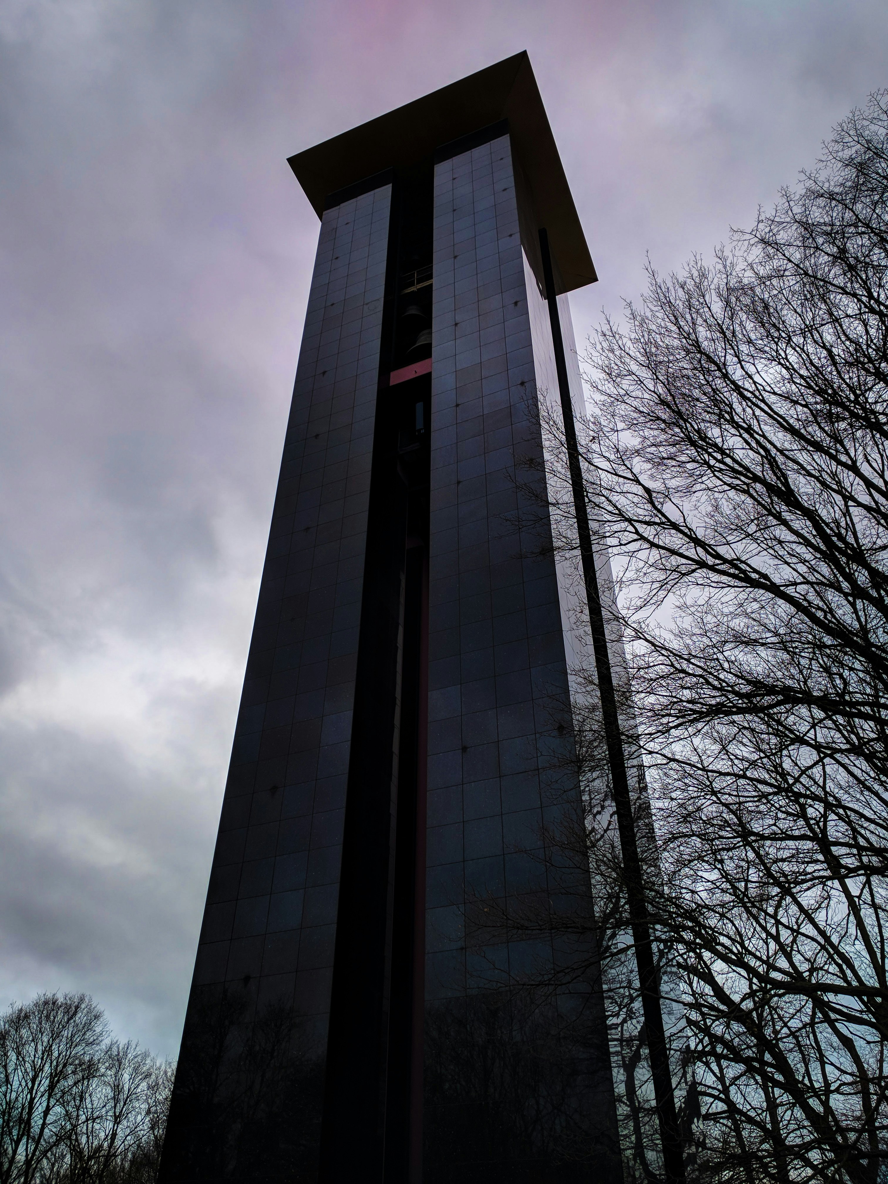 Monolithic Tower Piercing a Cloudy Winter Sky