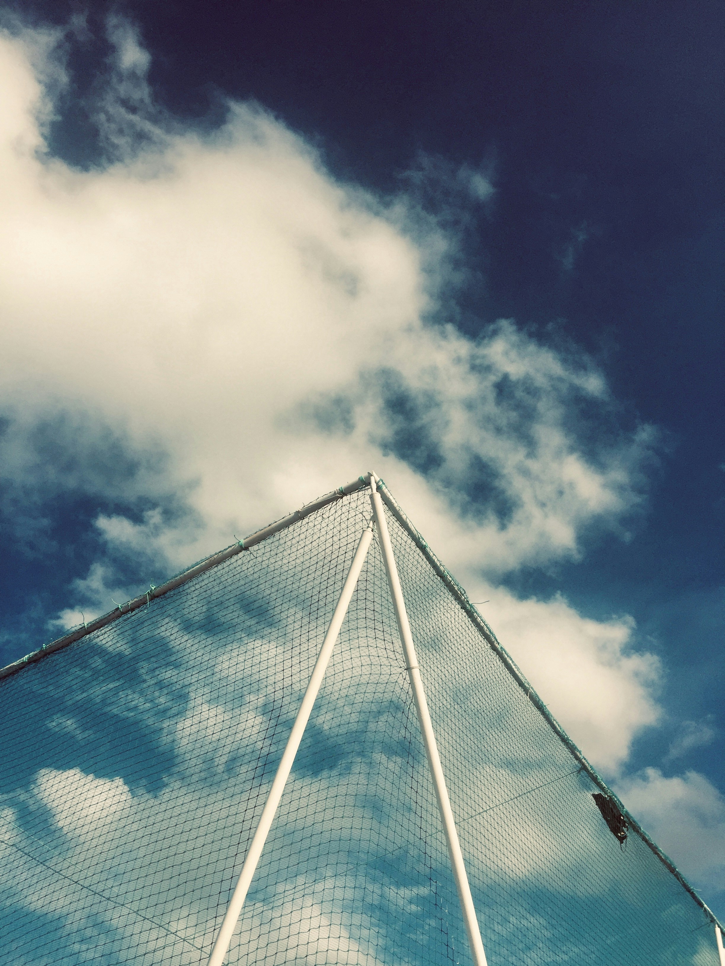 Pole and Netline Reaching Toward a Luminous Sky