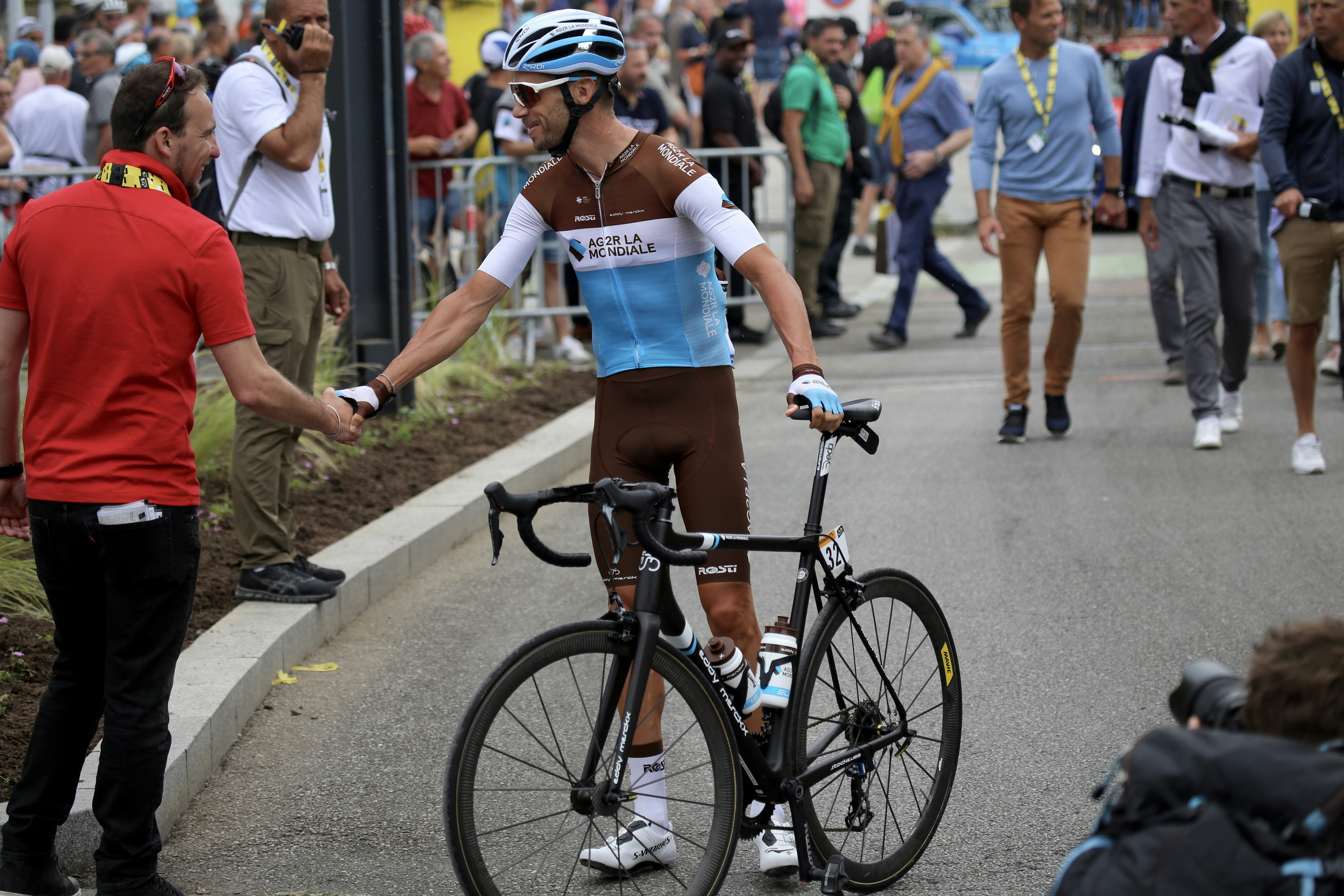 Handshake on the Road: Cyclist in a Moment of Support