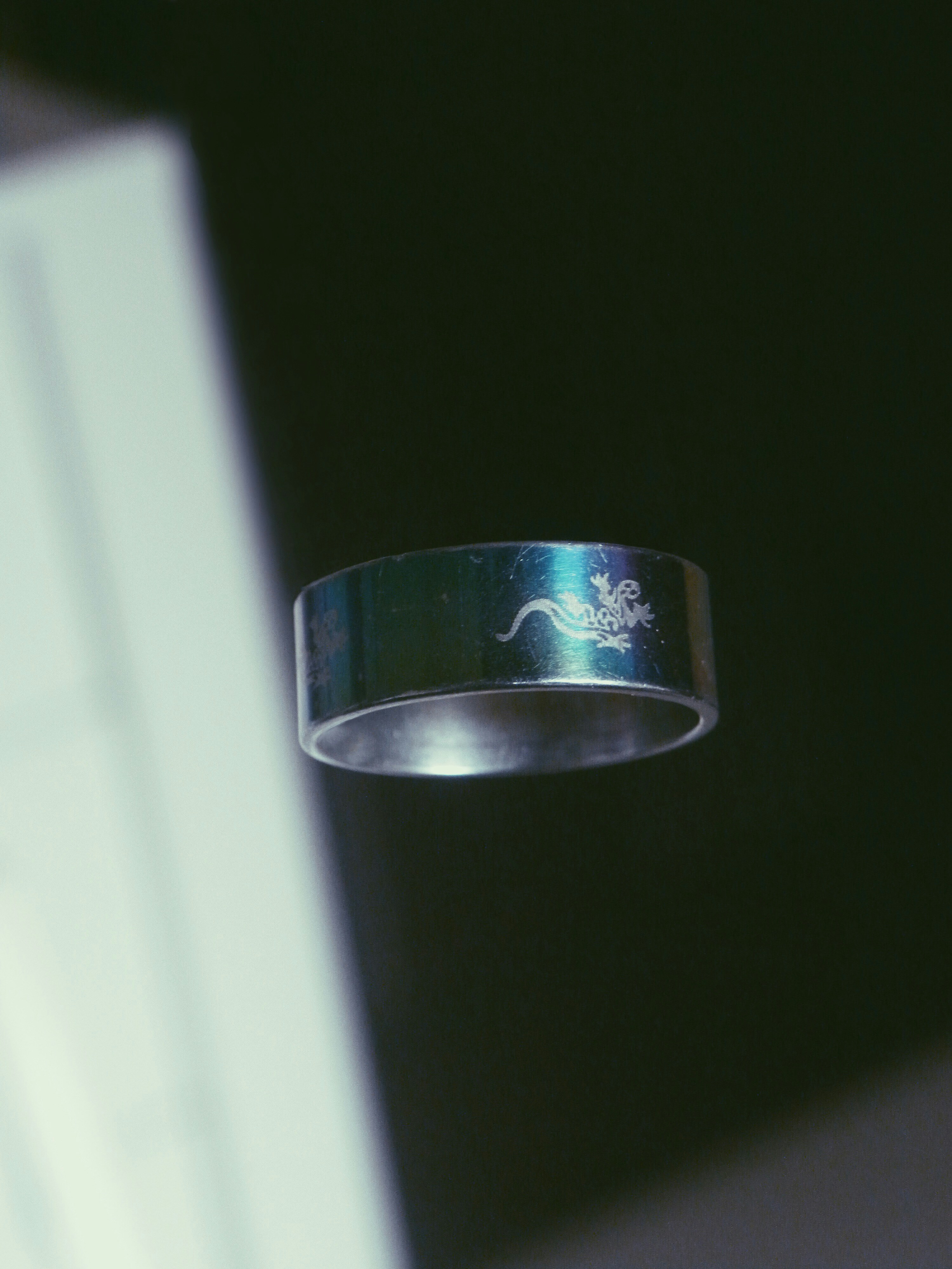 Hovering Dragon-Engraved Ring in a Shadowed Doorway