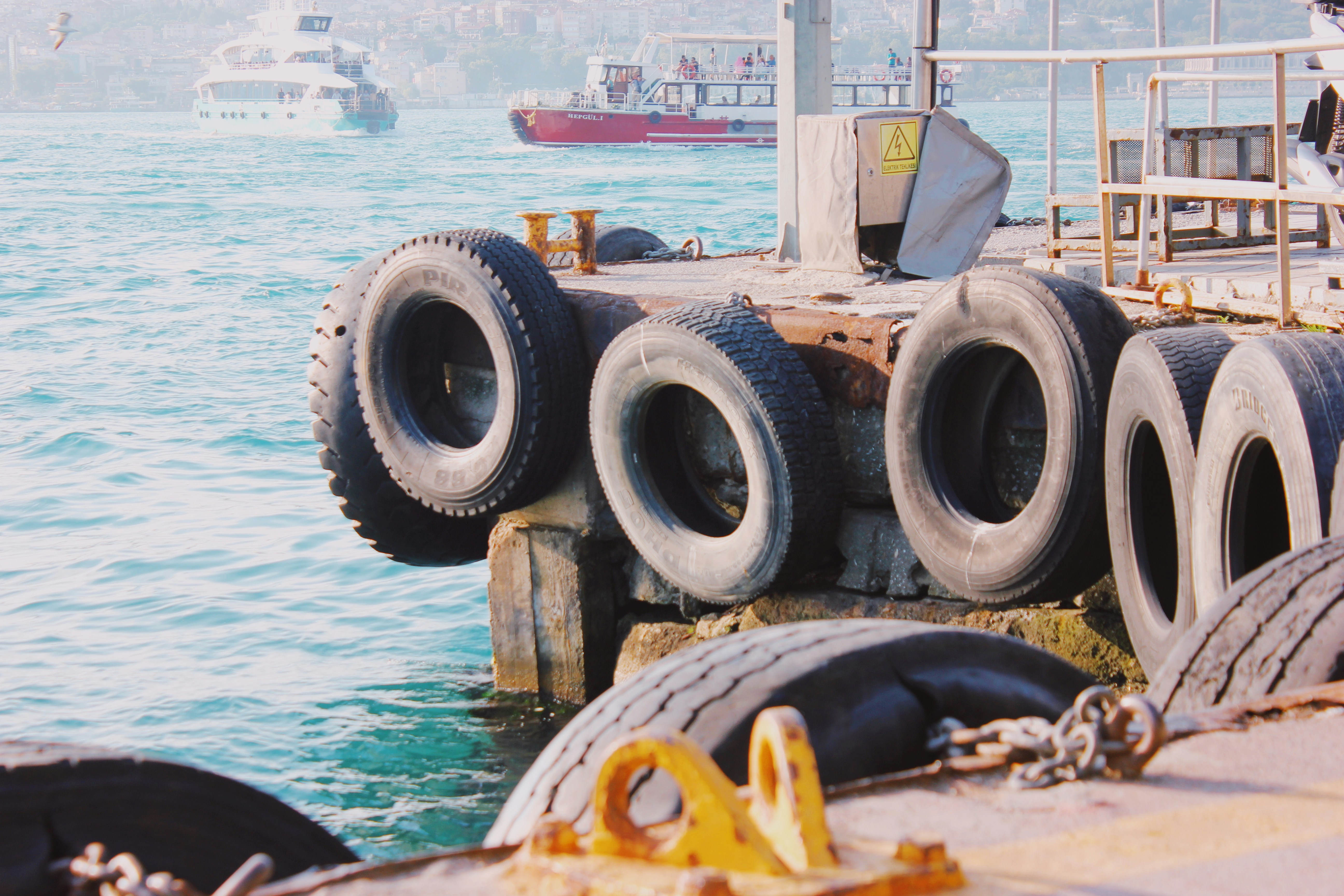 Dockside Circles: Weathered Tires Framing Turquoise Harbor