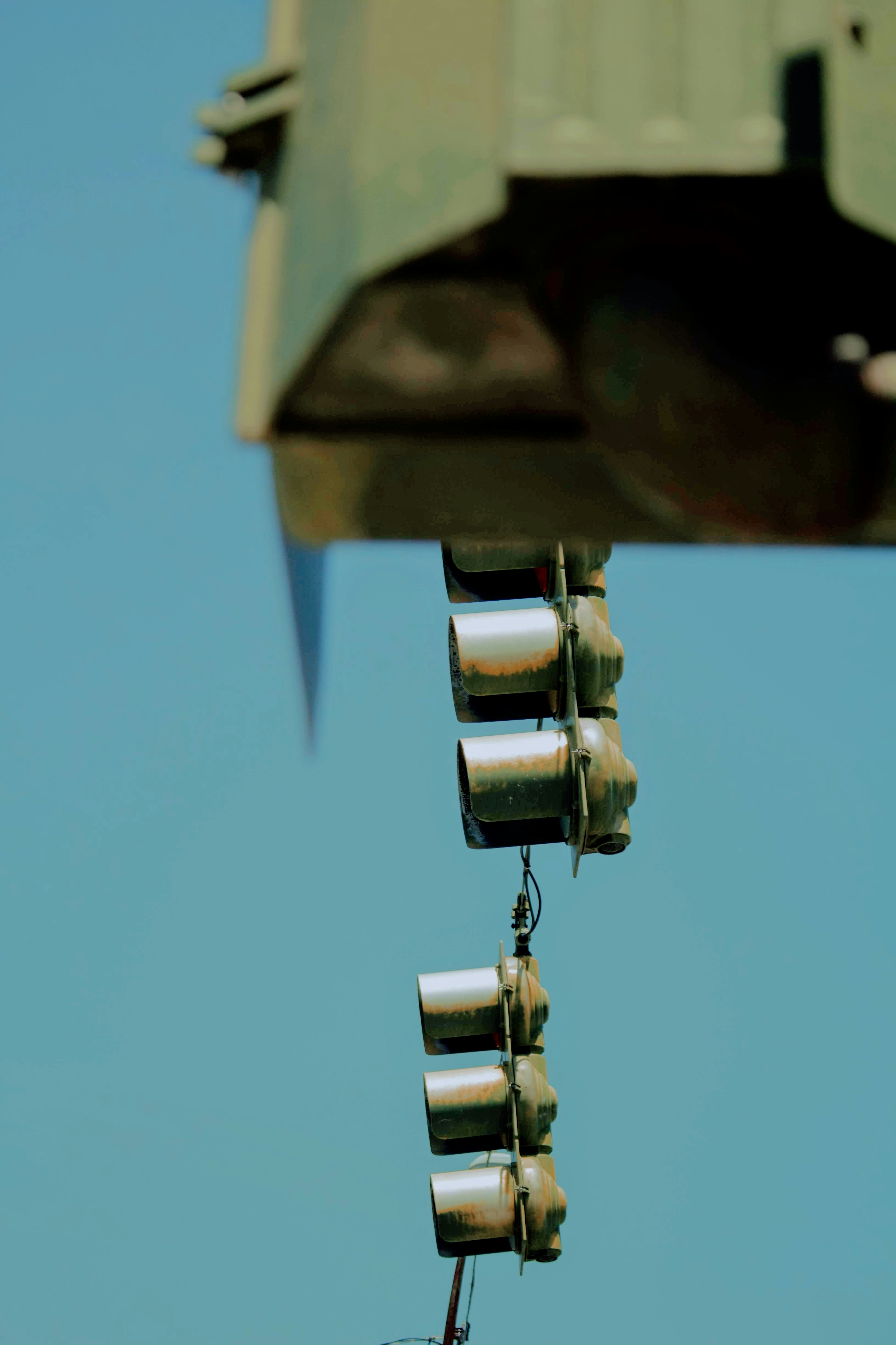 Suspended Rails: A Vertical Chain of Cylinders Against a Clear Sky