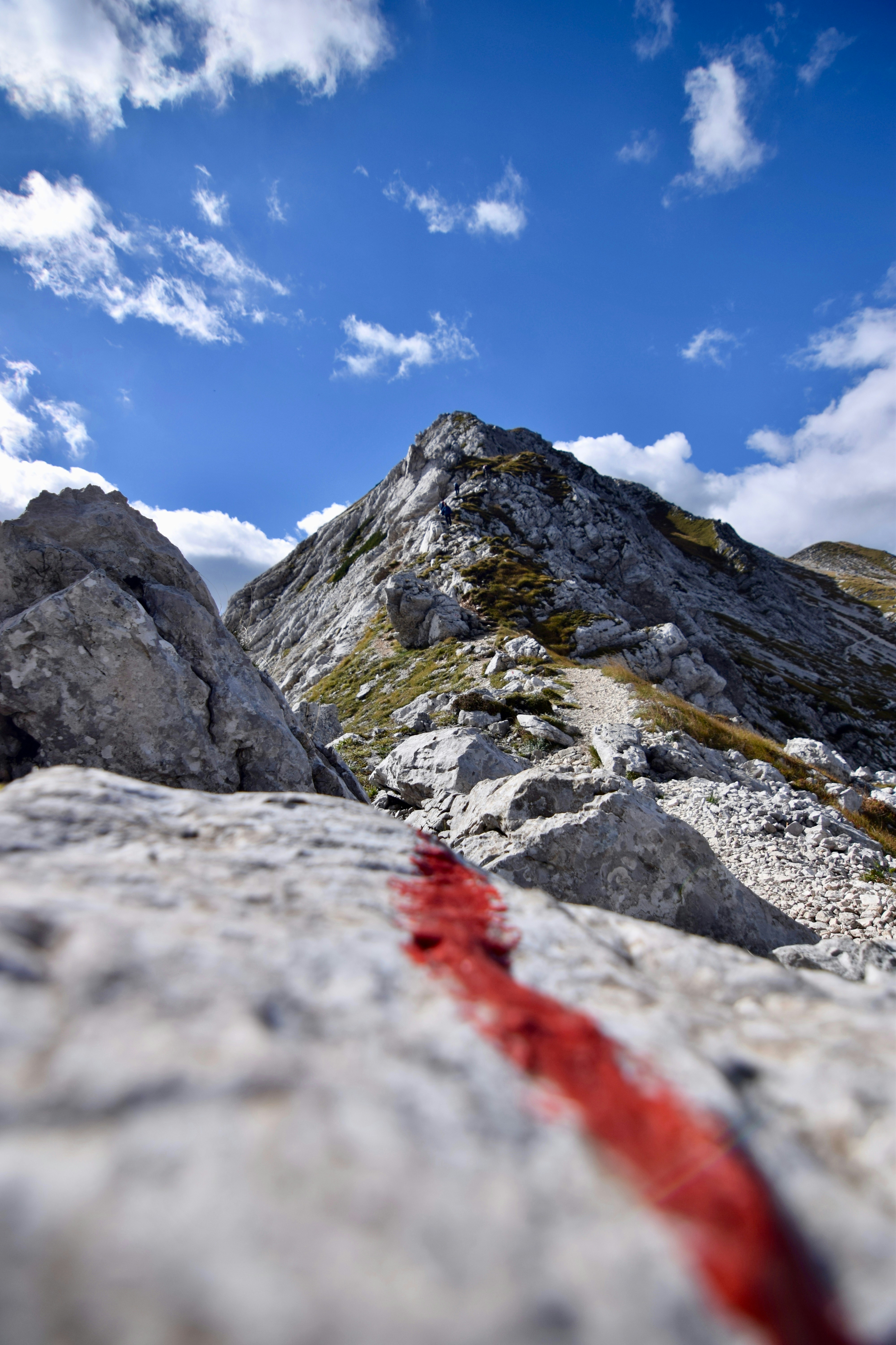 Trail's Edge: Rocky Ascent Under Blue Skies