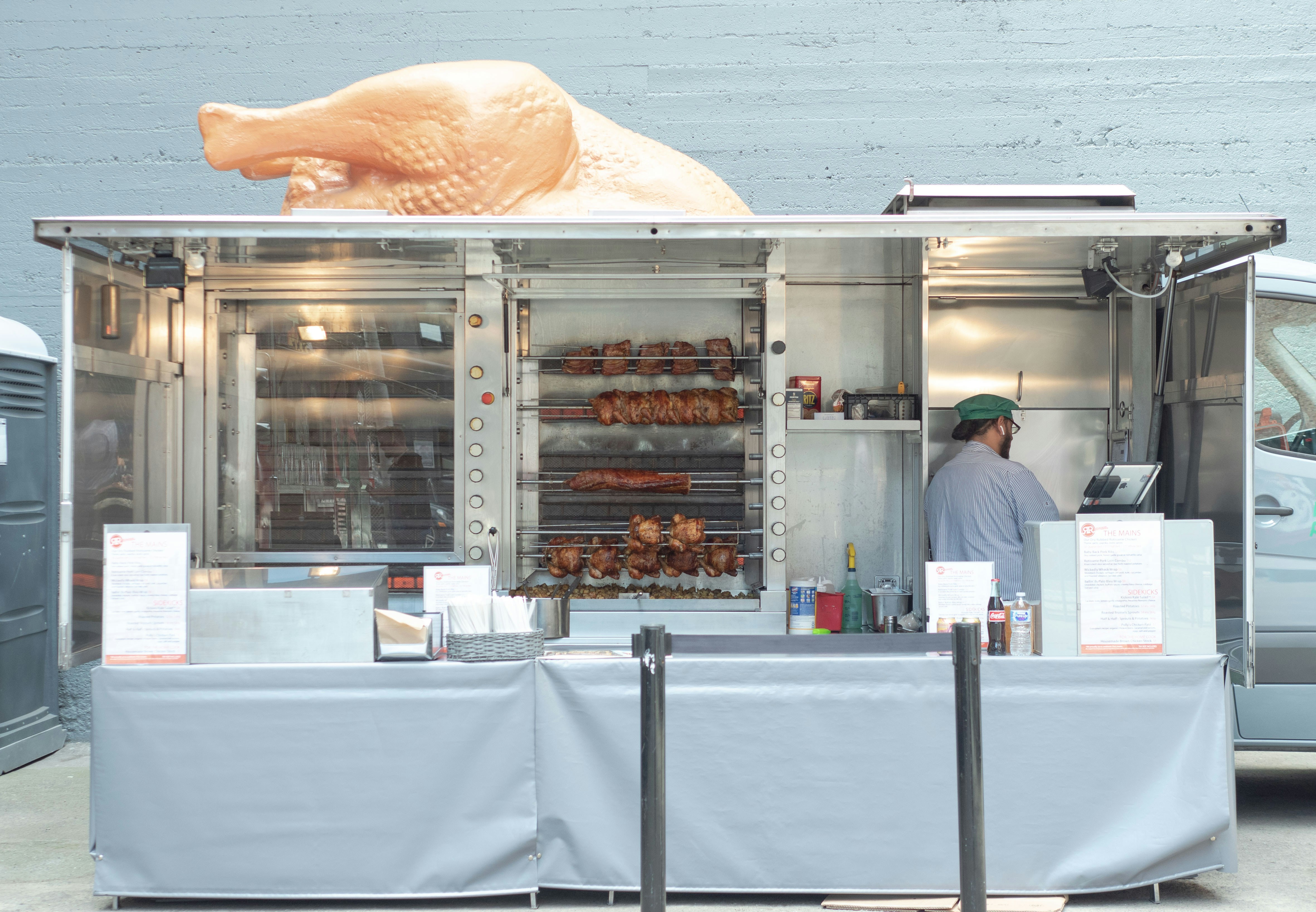 Rotisserie Alley: A Food Truck Under a Surreal Giant Foot