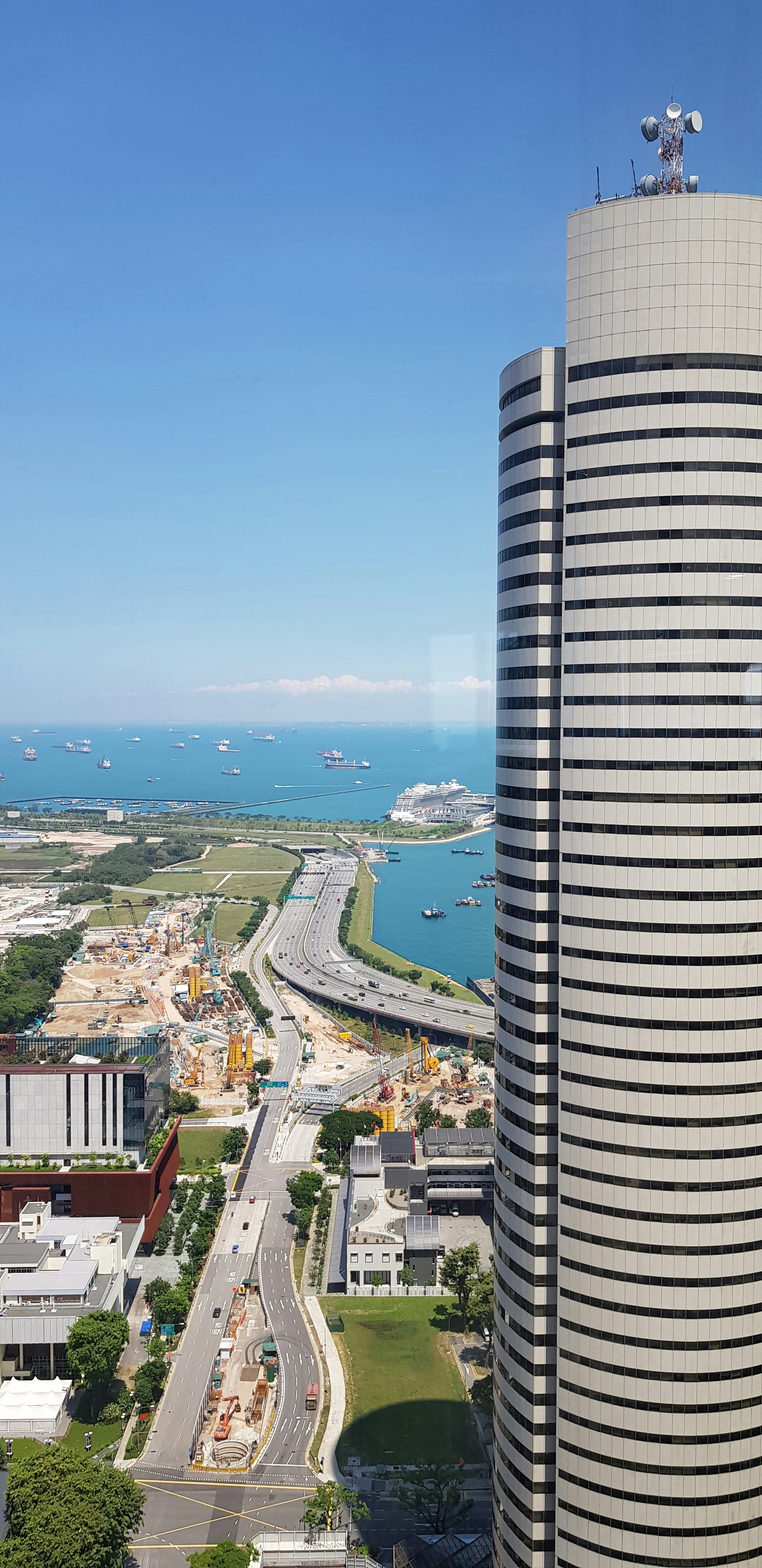 Towering Glass & Waterfront Corridor: A Cityscape Unfolding Along the Coast