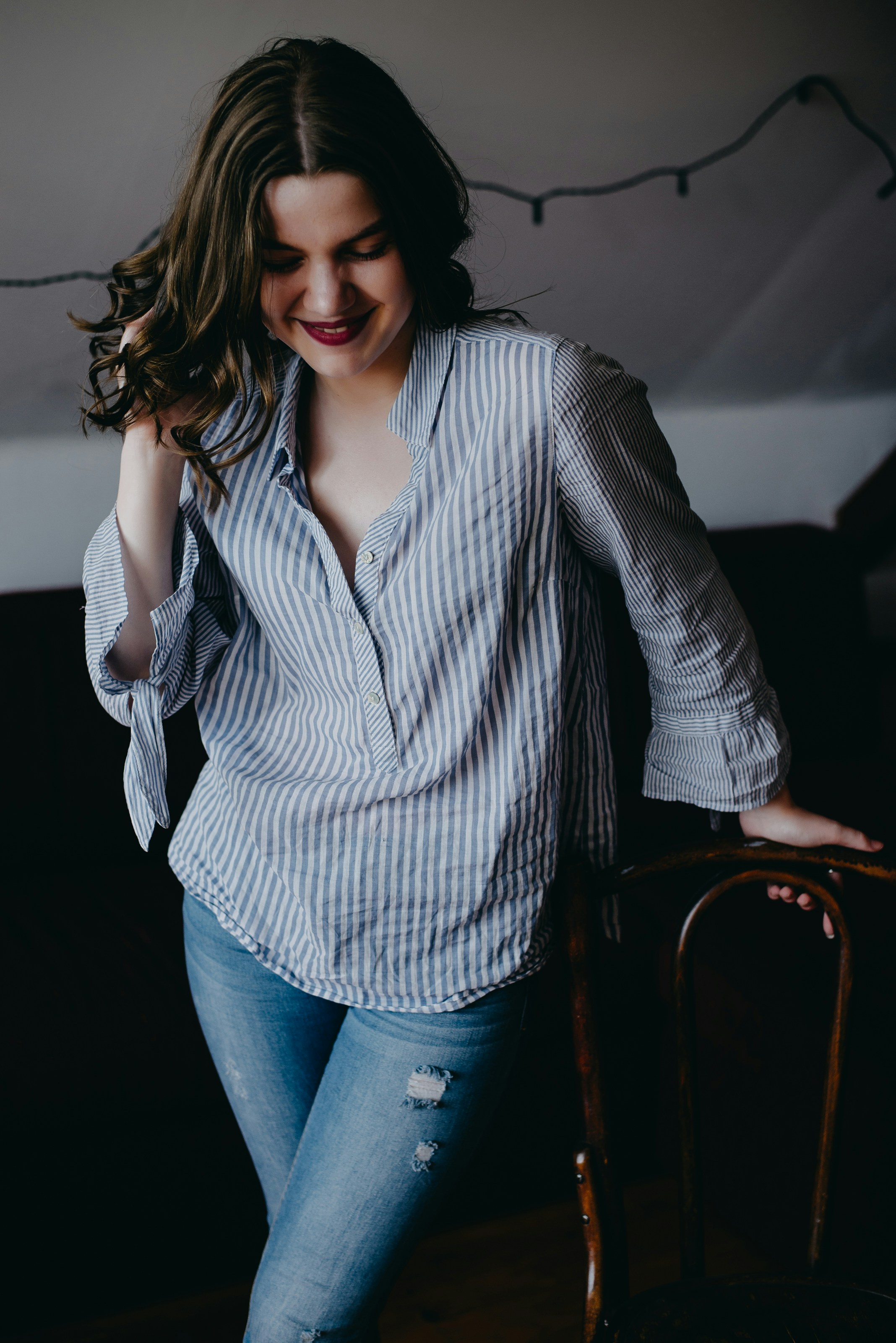 Smirking woman holding chair photo – Free Grey Image on Unsplash