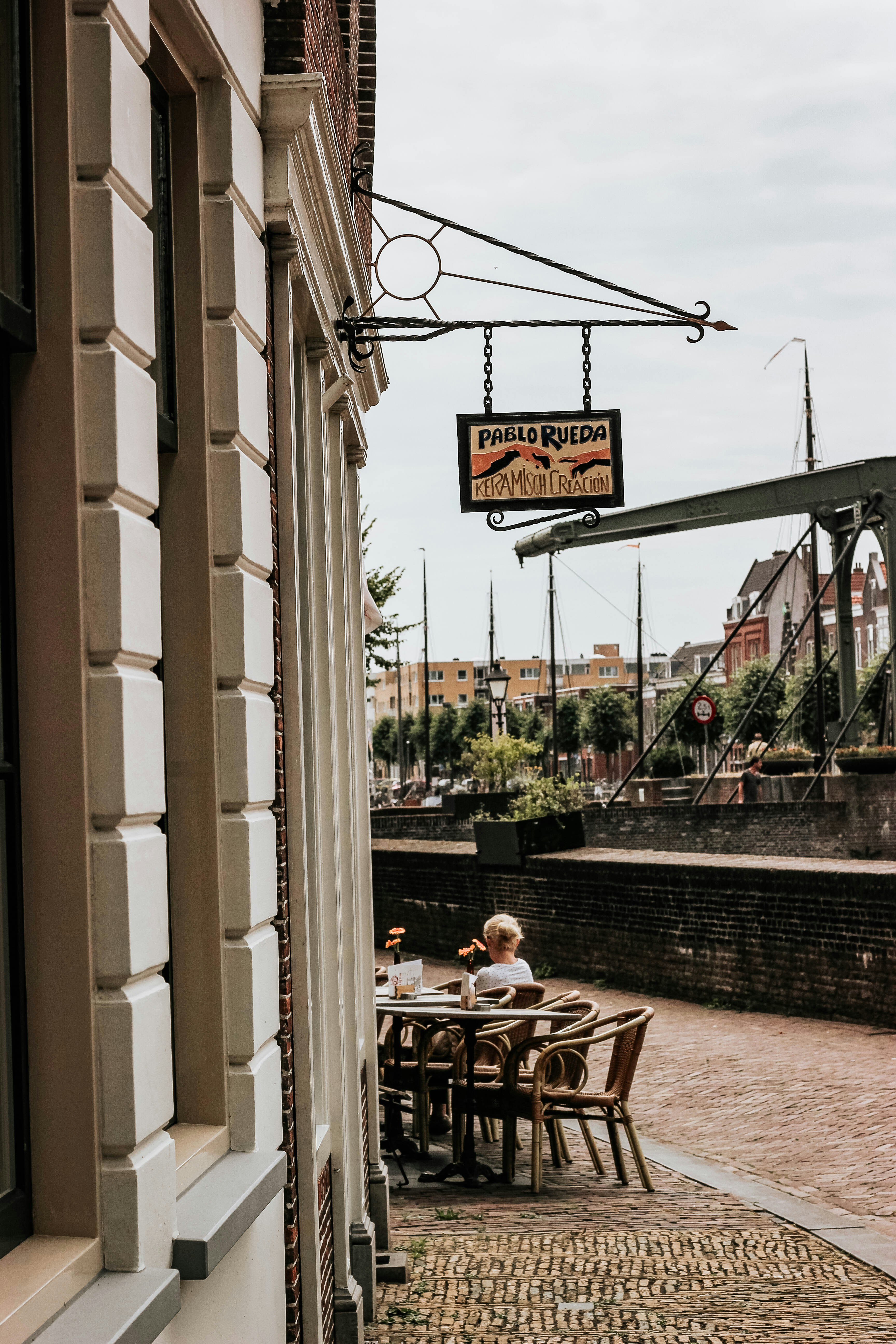 Cobbled Quai & Sign: A Quiet Afternoon by the Canal