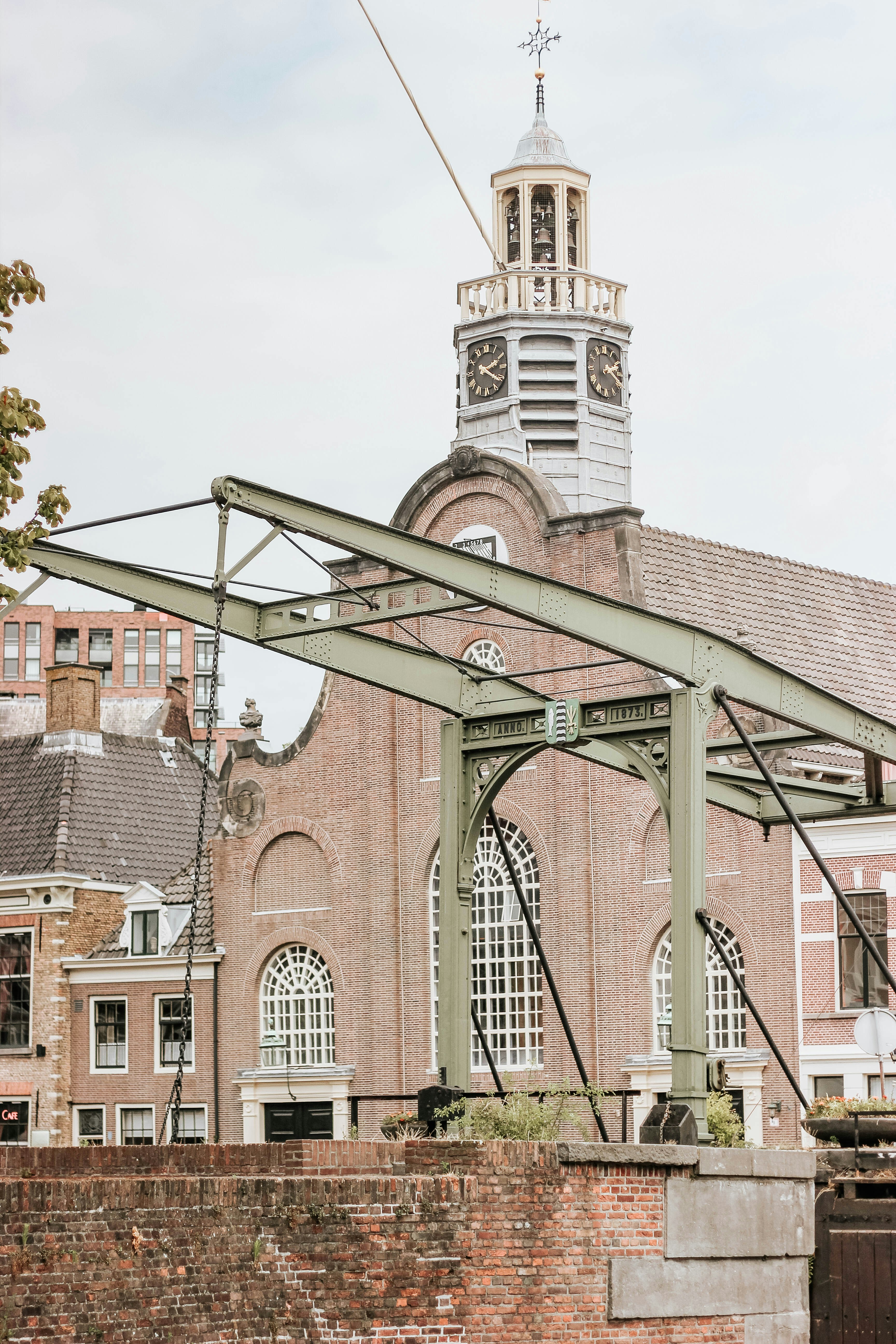 Past and Present: The Clock Tower Framed by a Green Lift Bridge