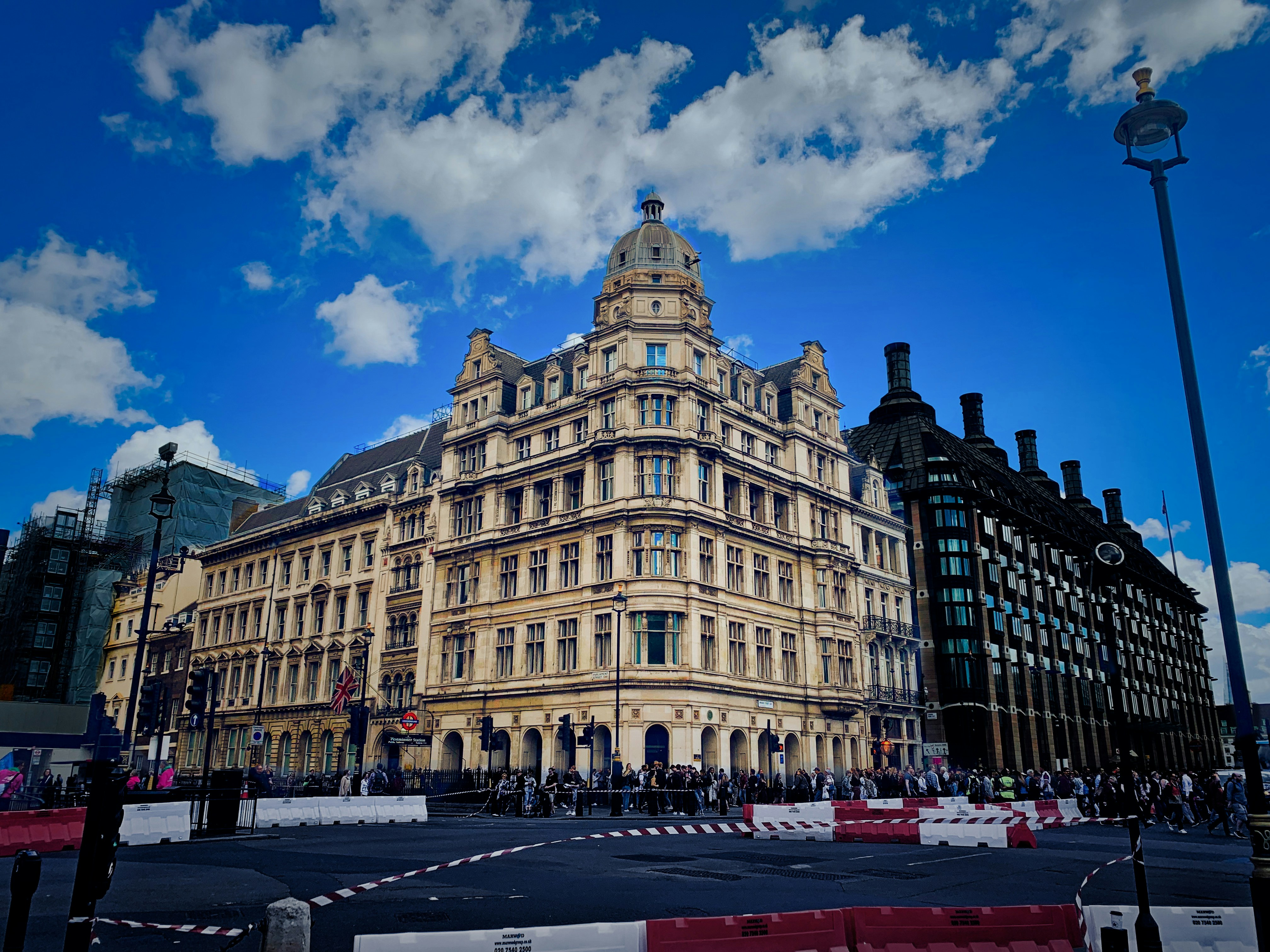Ornate Victorian building framed by a vivid blue sky with scattered clouds.
