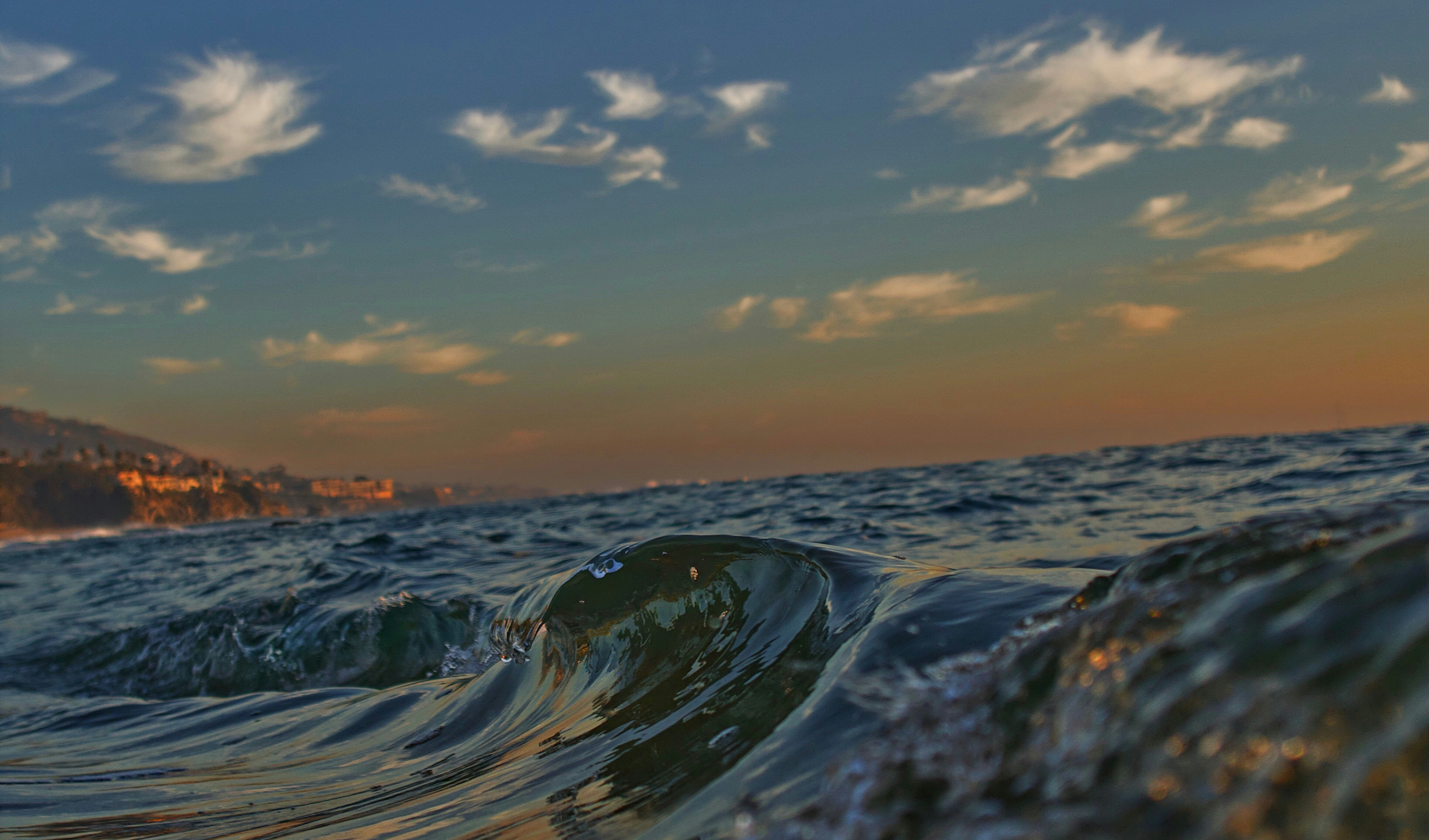 Dusk Crest at the Waterline: A Close-Up of a Curling Wave