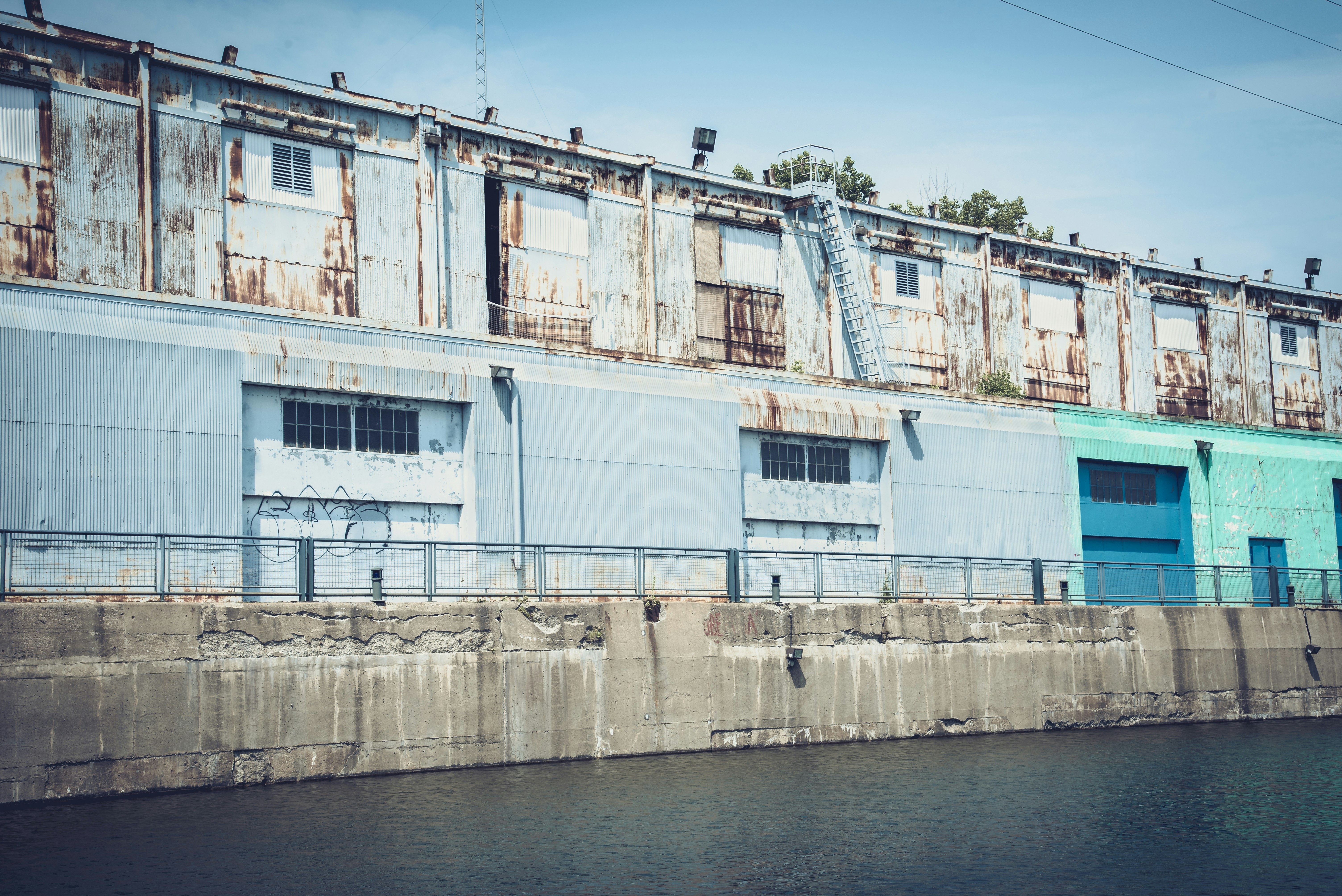 Rusted Riverside: Industrial Facade Along a Quiet Canal