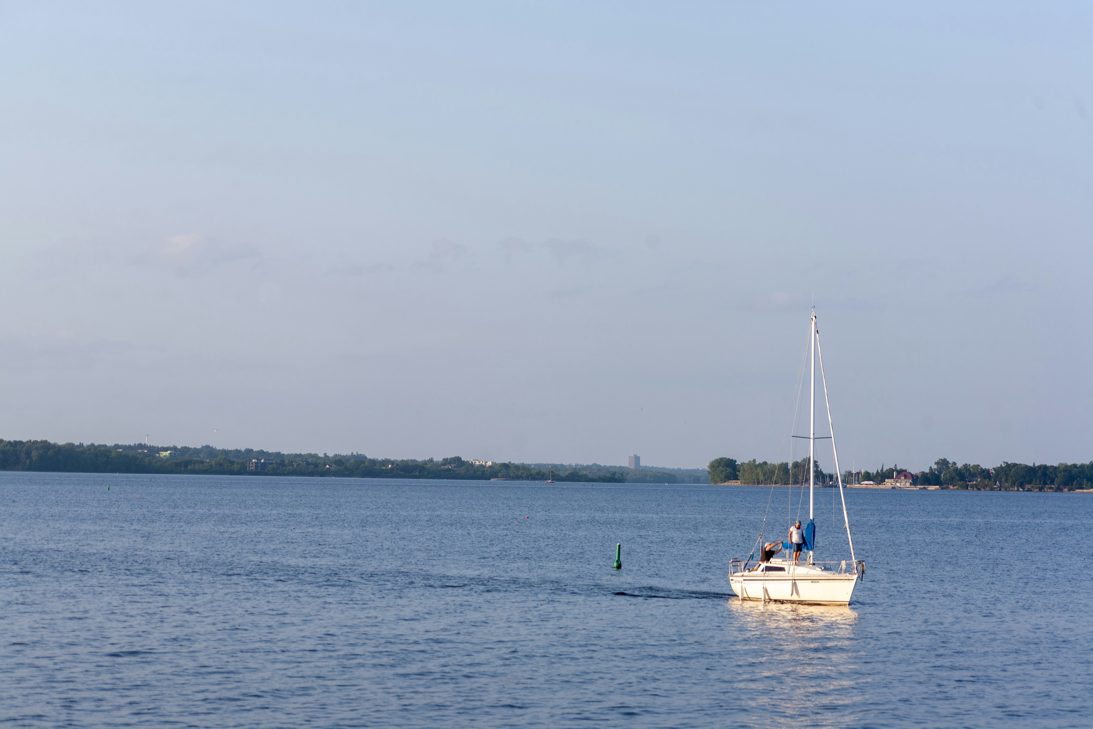 A sailboat floating on a large body of water photo – Free #river Image ...