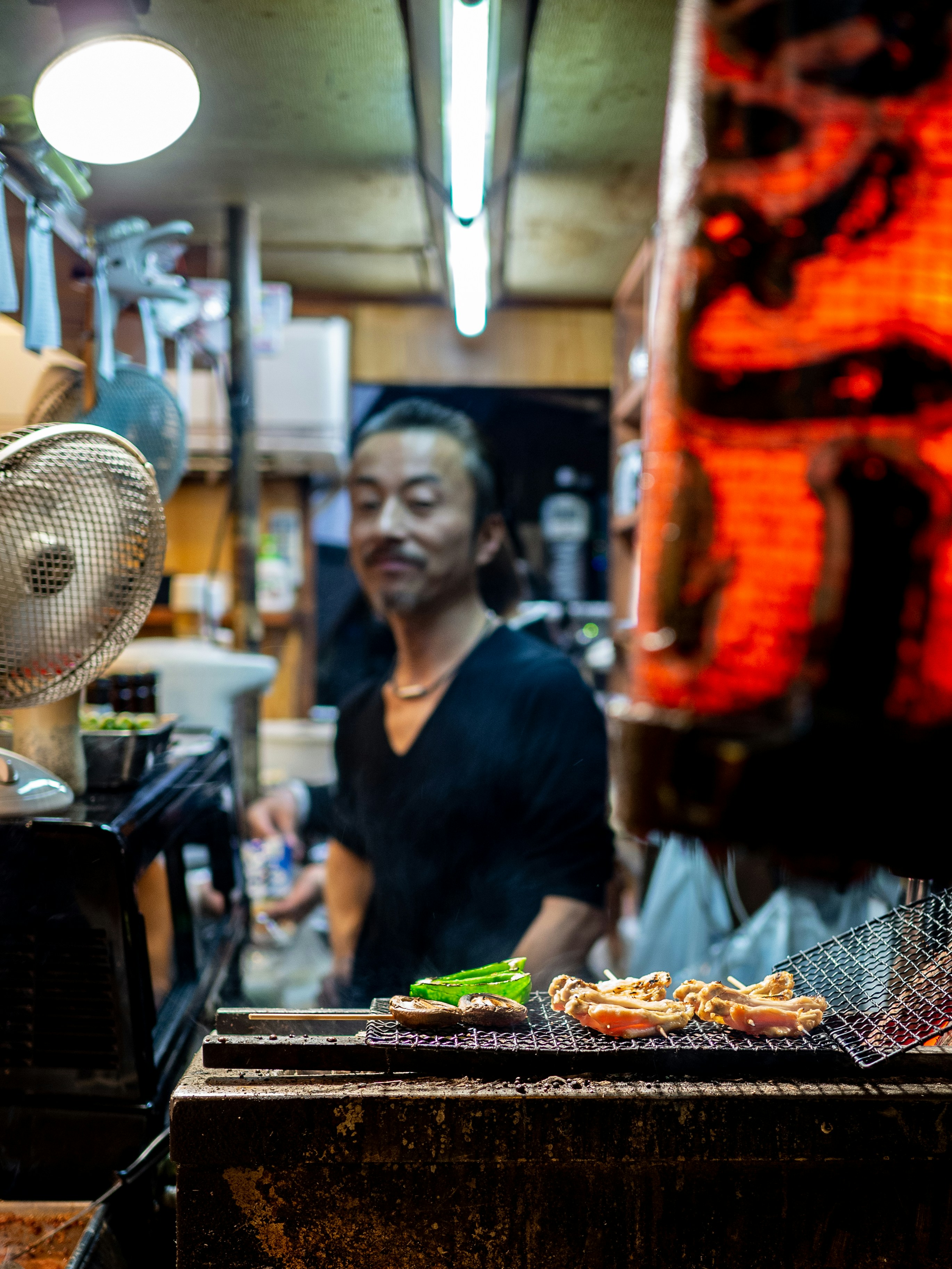 a man standing in a kitchen preparing food