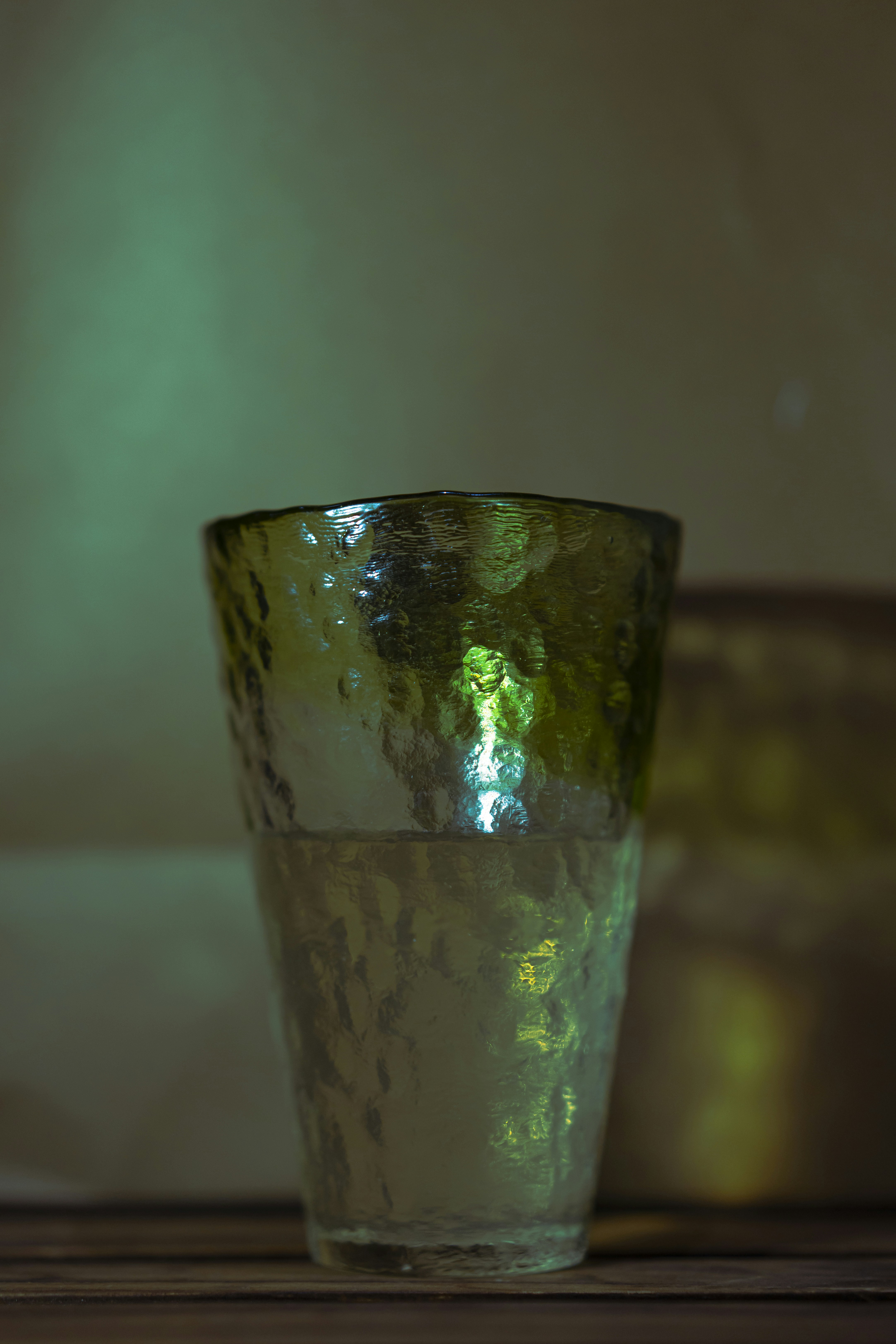Emerald Glass in a Quiet Green Glow on Weathered Wood