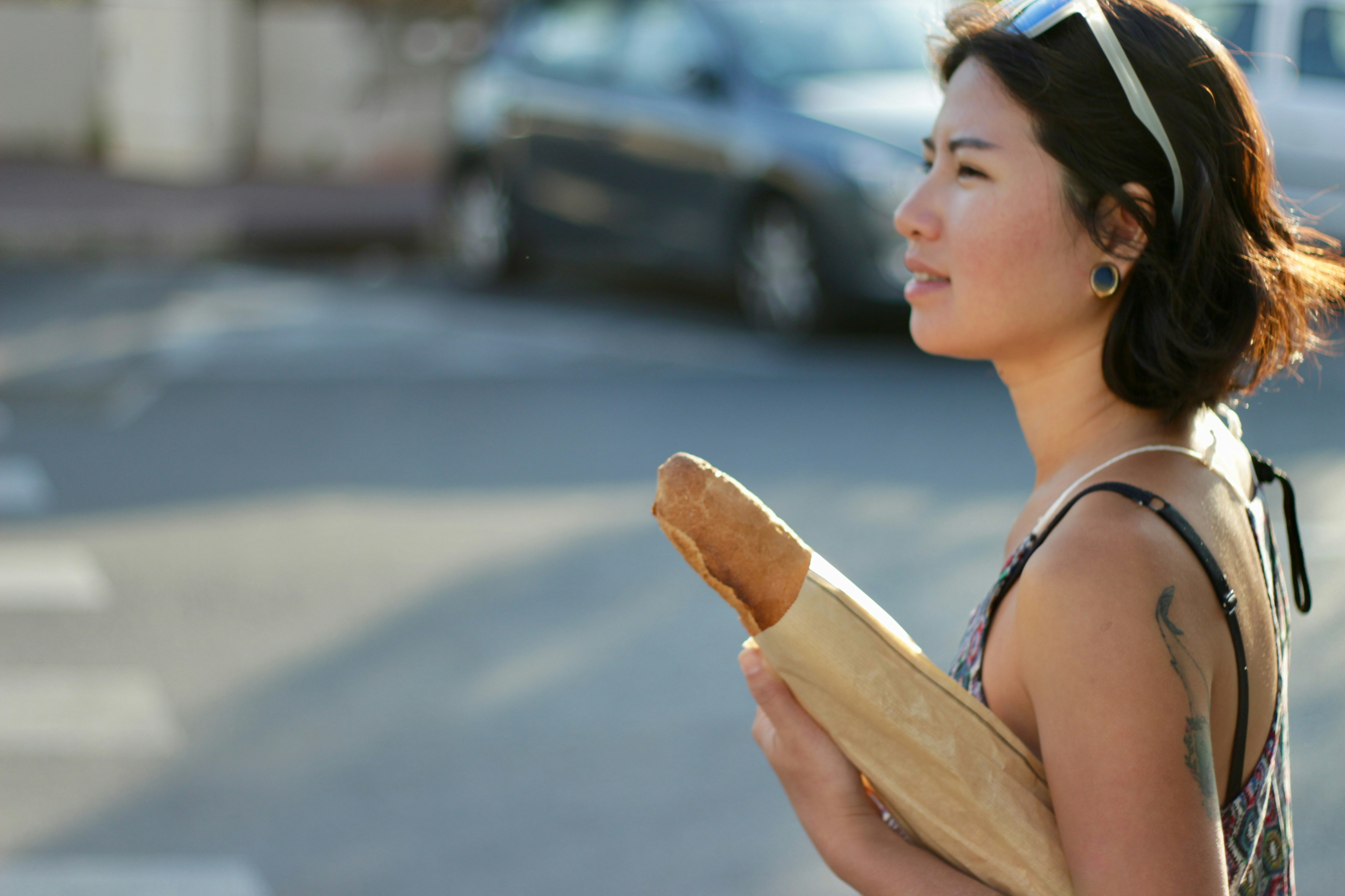 Woman carrying bread photo – Free Grey Image on Unsplash